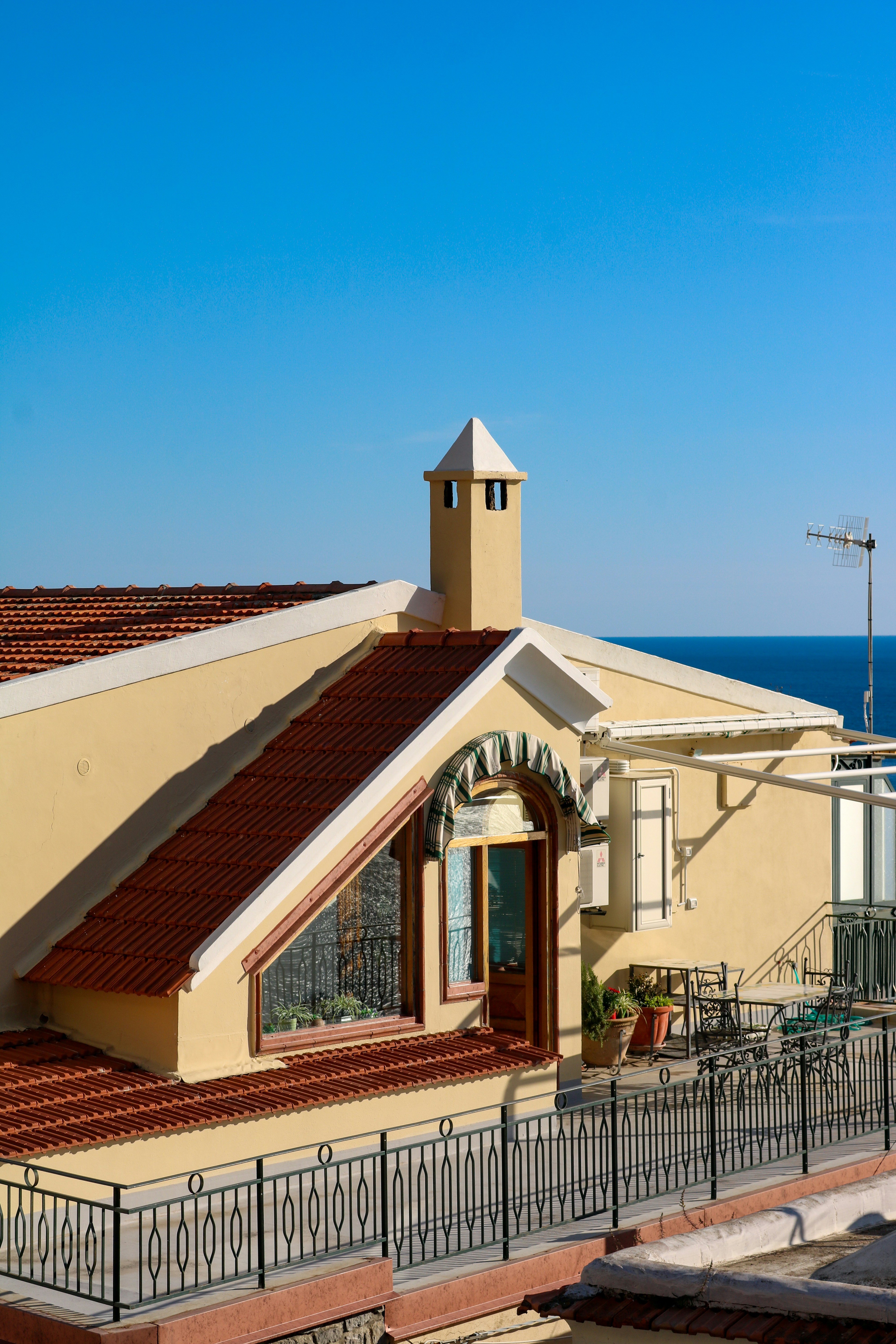 Sunlit Terrace: Mediterranean Rooftops and Sea Horizon