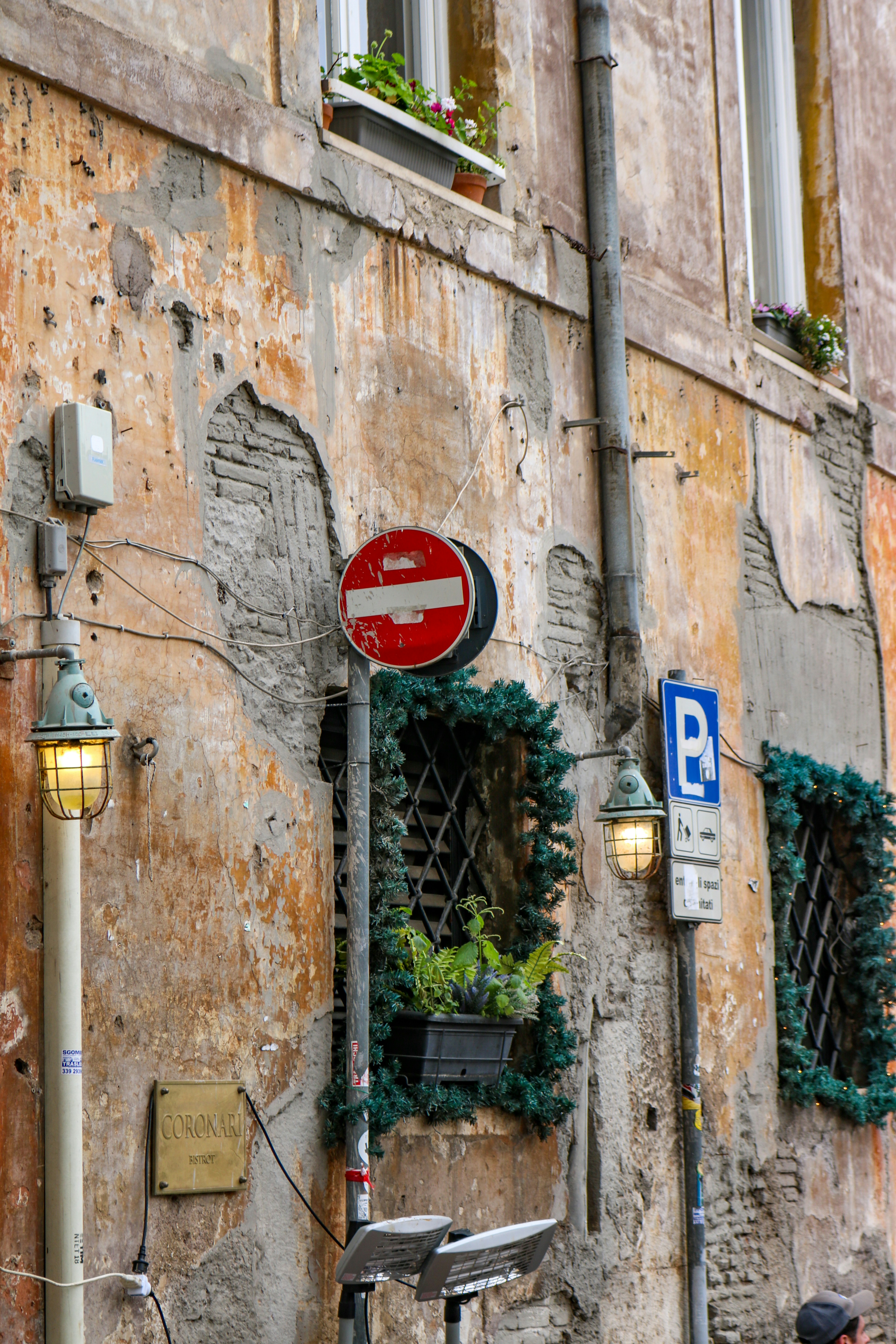 Weathered Facade Street Scene with Wrought-Iron Windows and Quiet Signage