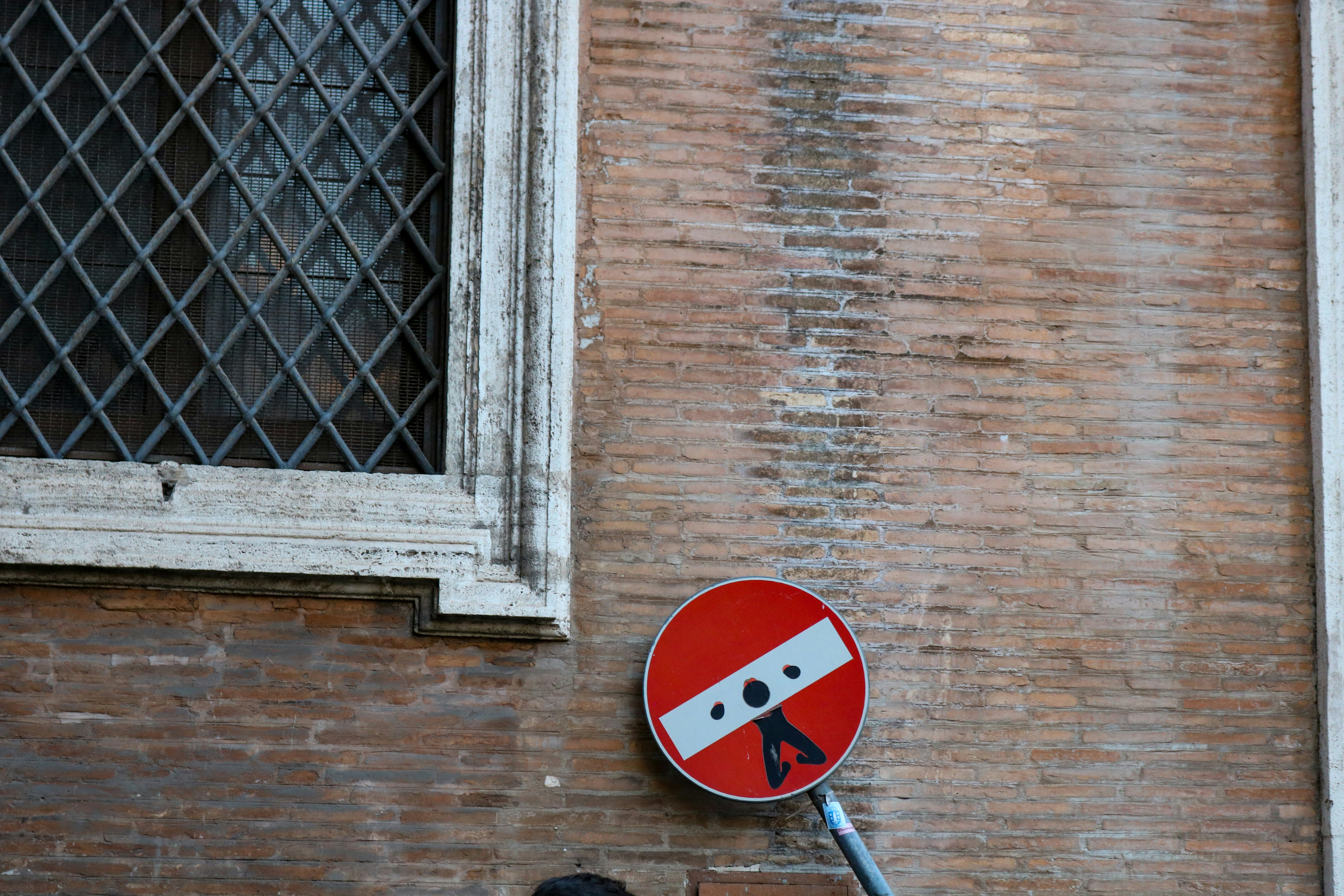 No Entry Triangle: A Weathered Brick Wall and a Warning Sign