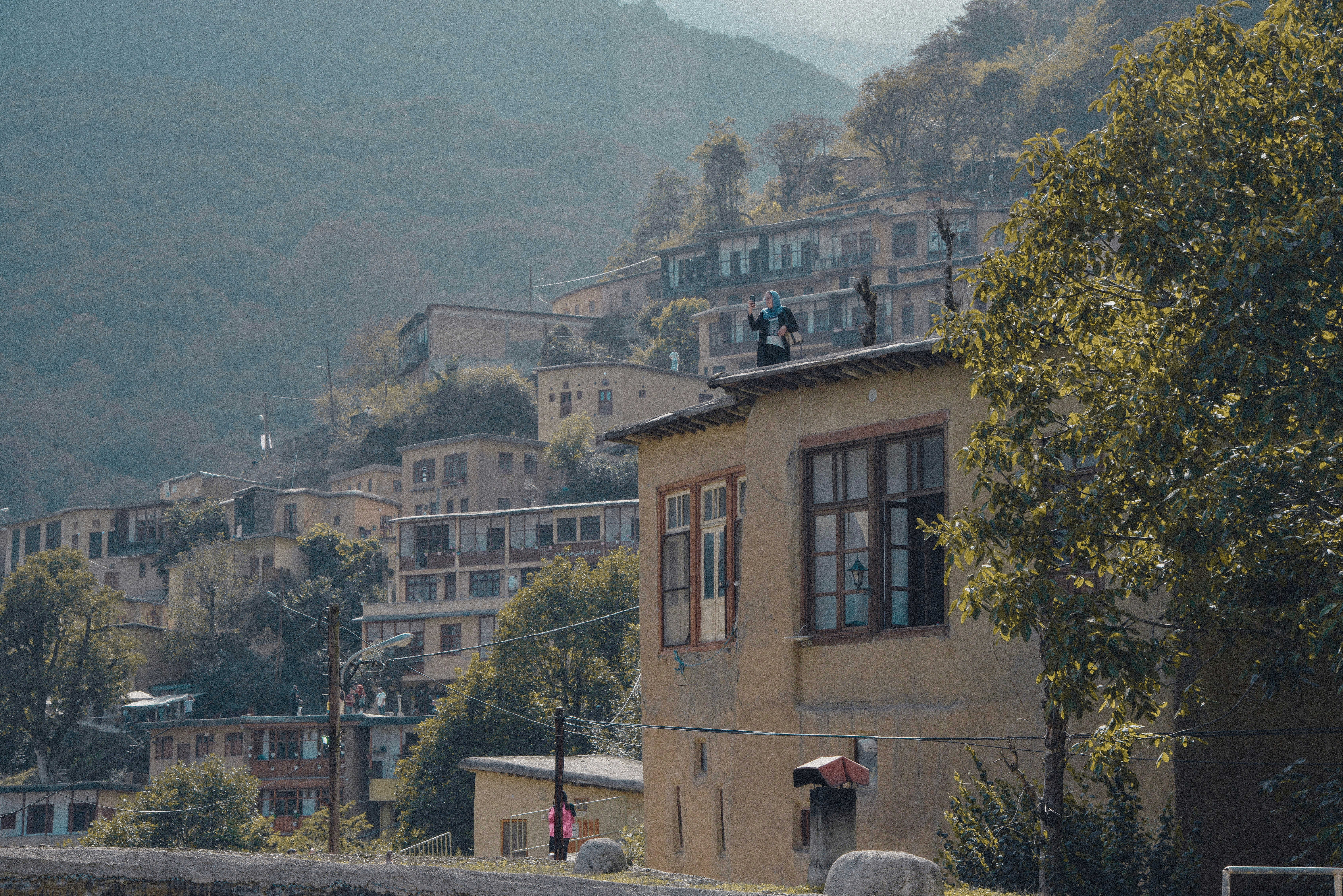 Ridge townwatch: a figure on the balcony watching over terraced houses