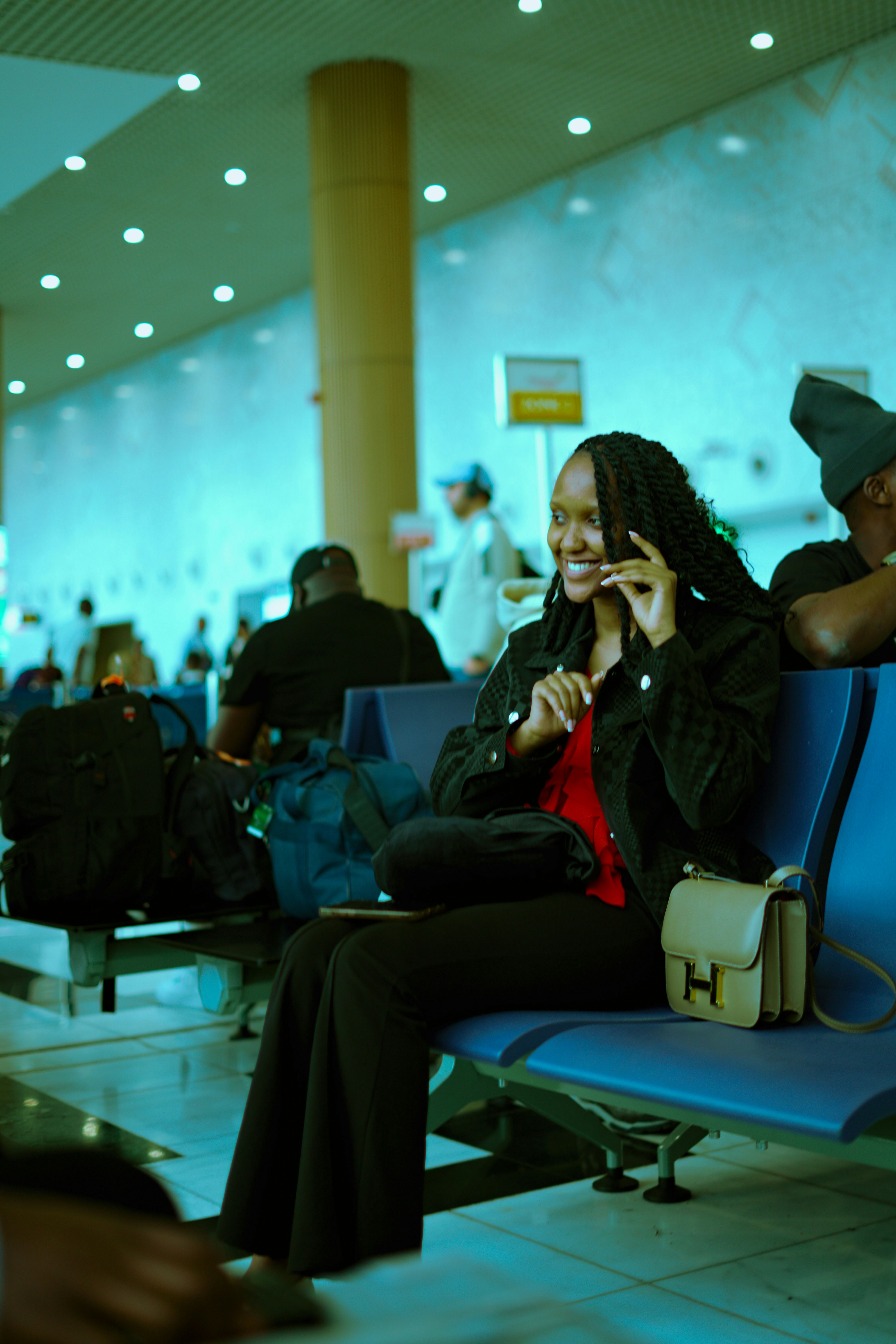 Smiling Traveler: Quiet Confidence in a Busy Terminal