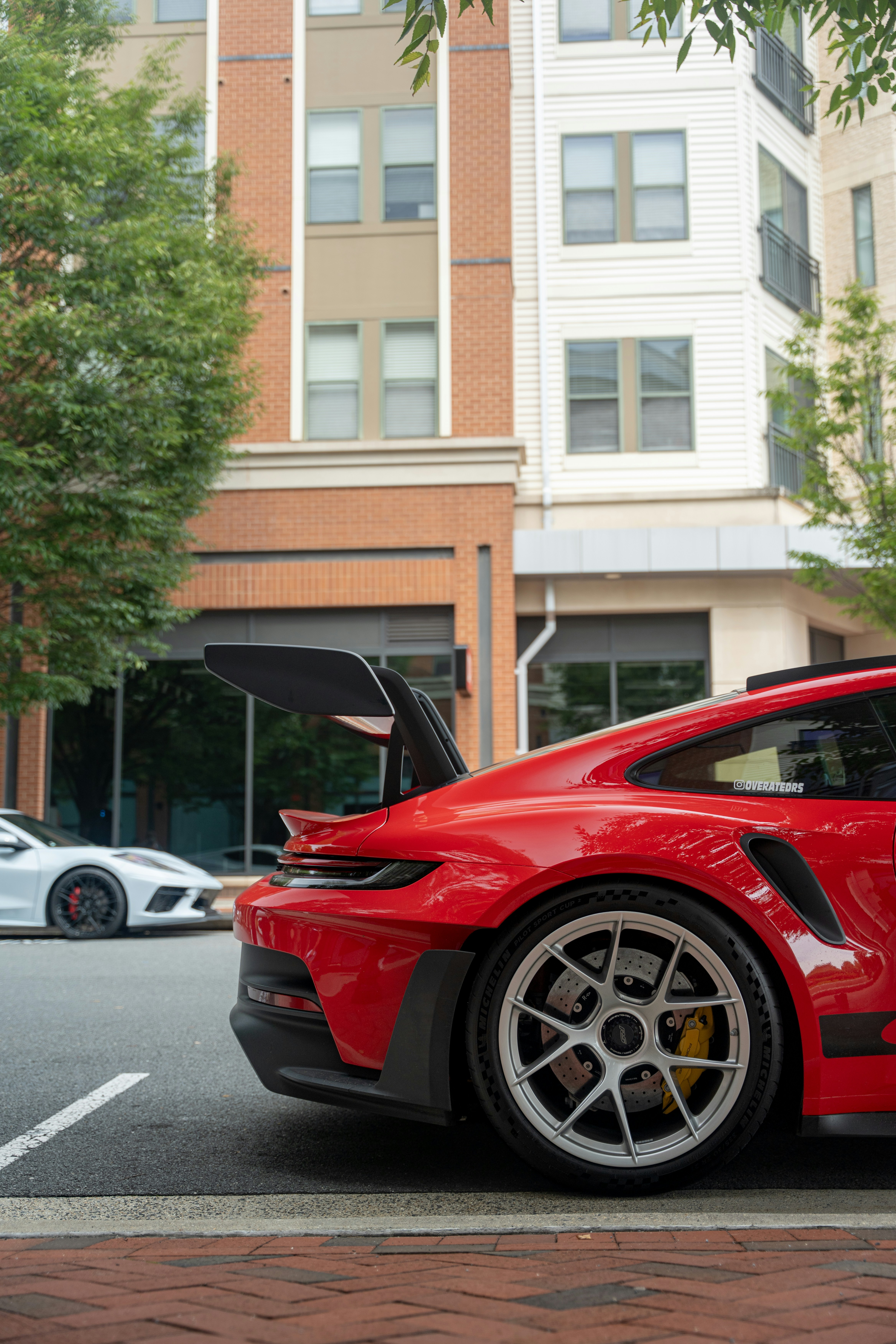 Rear Wing in the City: Red Porsche at a Quiet Street Edge