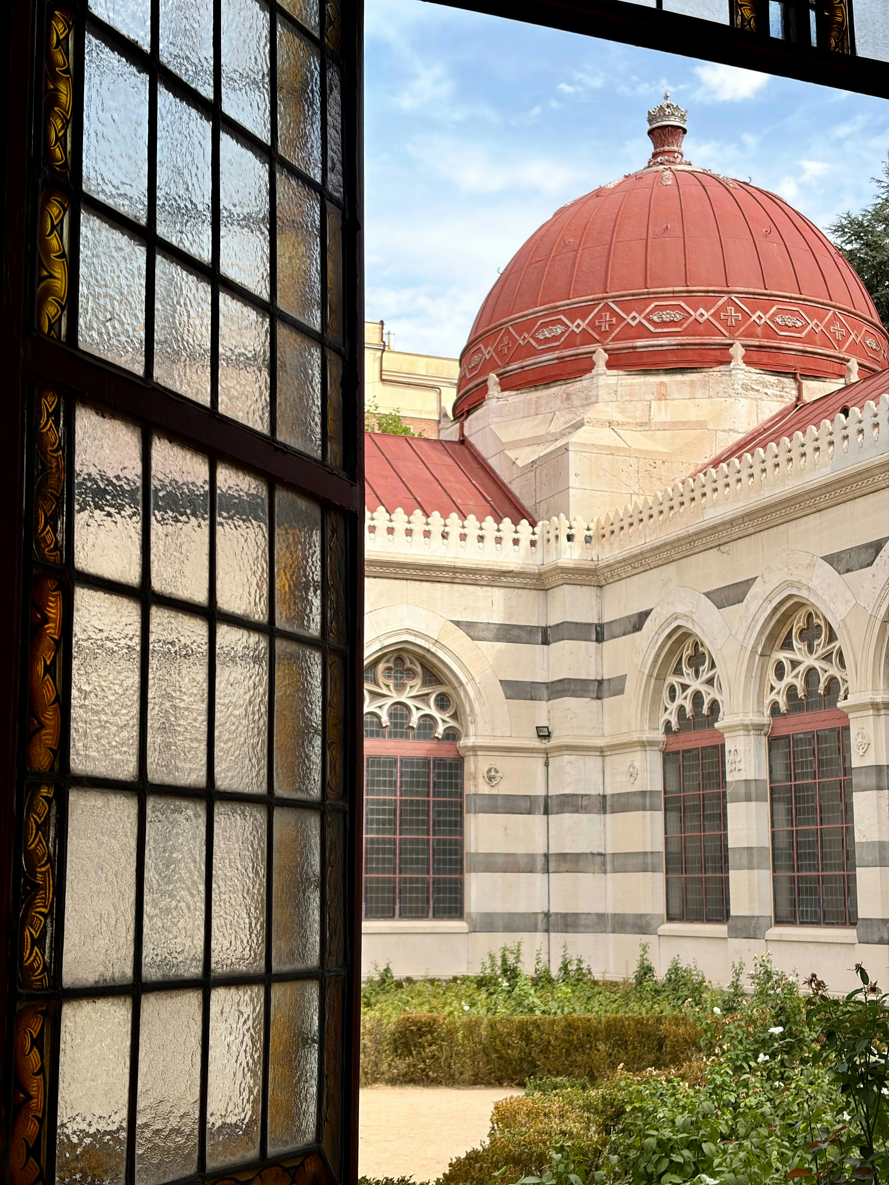 Arched Windows and Red Dome Framing a Historic Facade