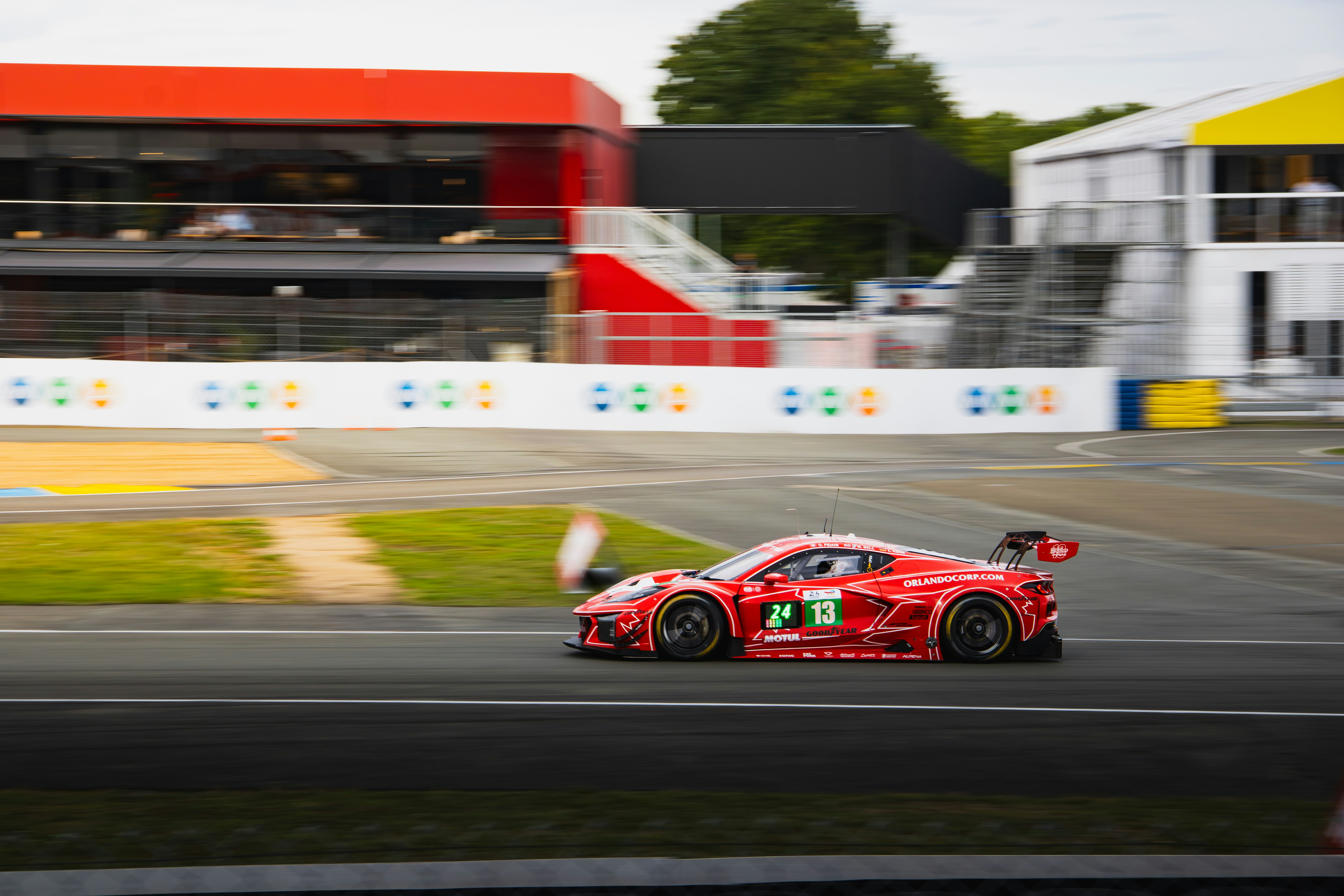 Red Race Car in Full Tilt on a Blurred Circuit
