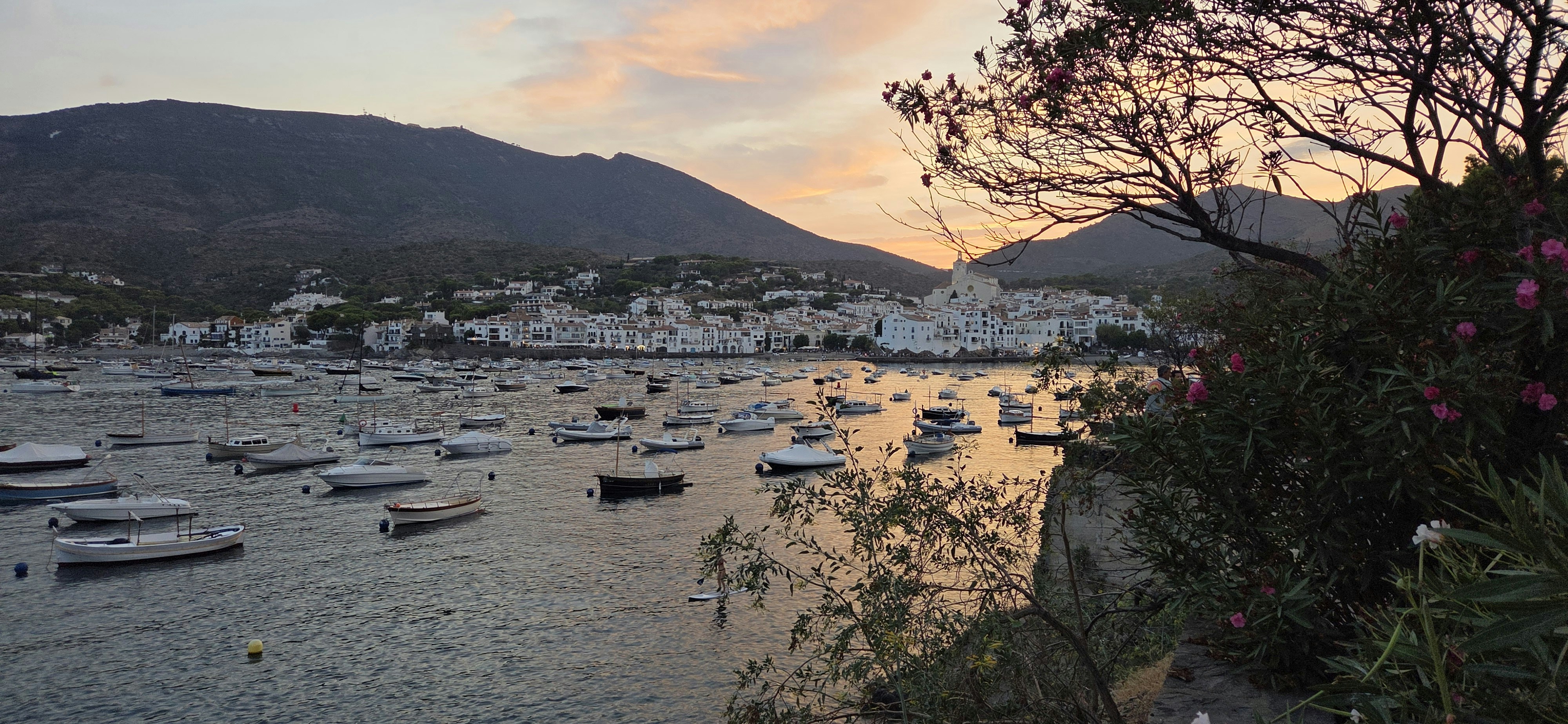 Sunset Harbor: Boats, Lights, and Coastal Hills