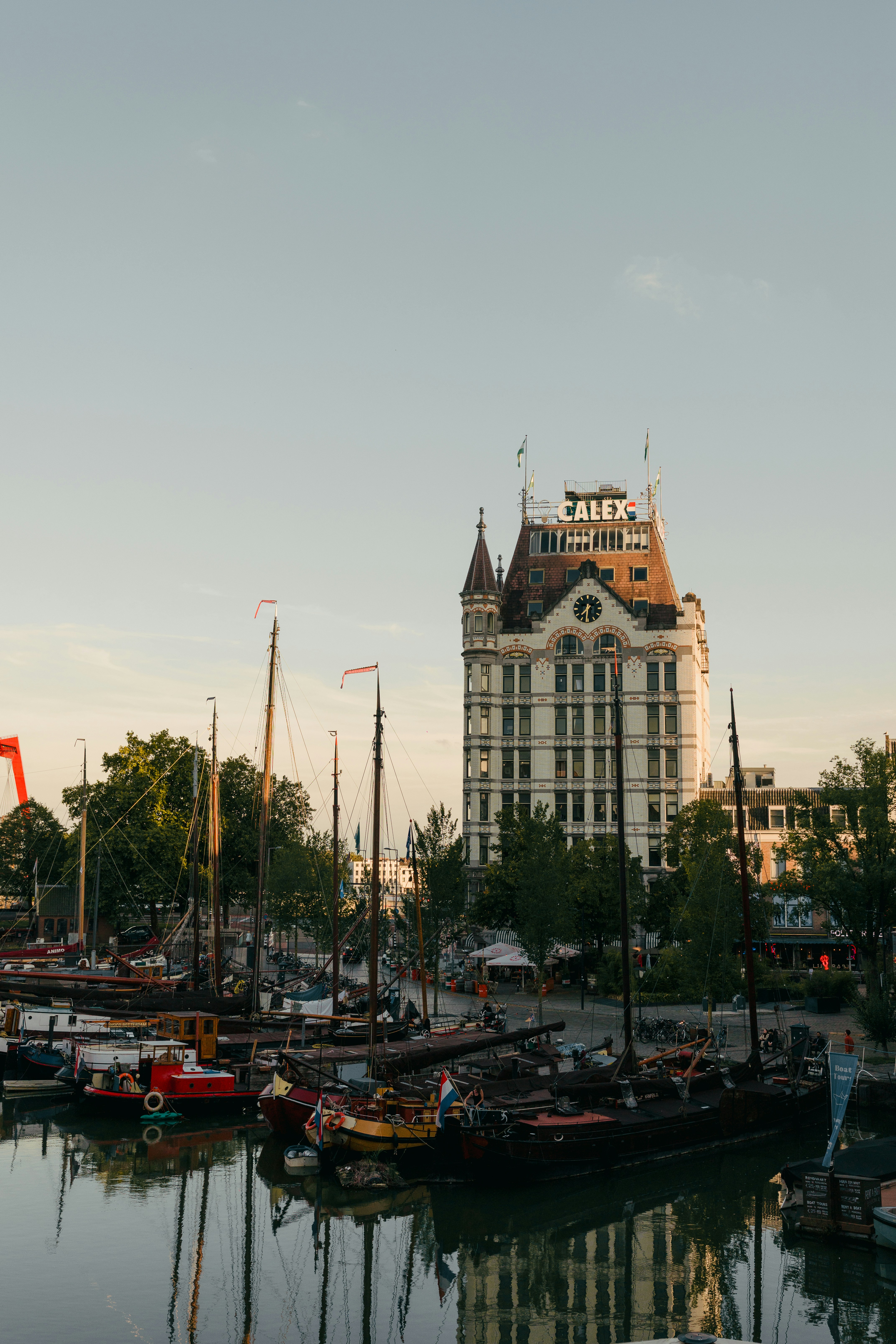 Harbor Sundown: Boats, Reflections, and a Clock-Towered Boutique