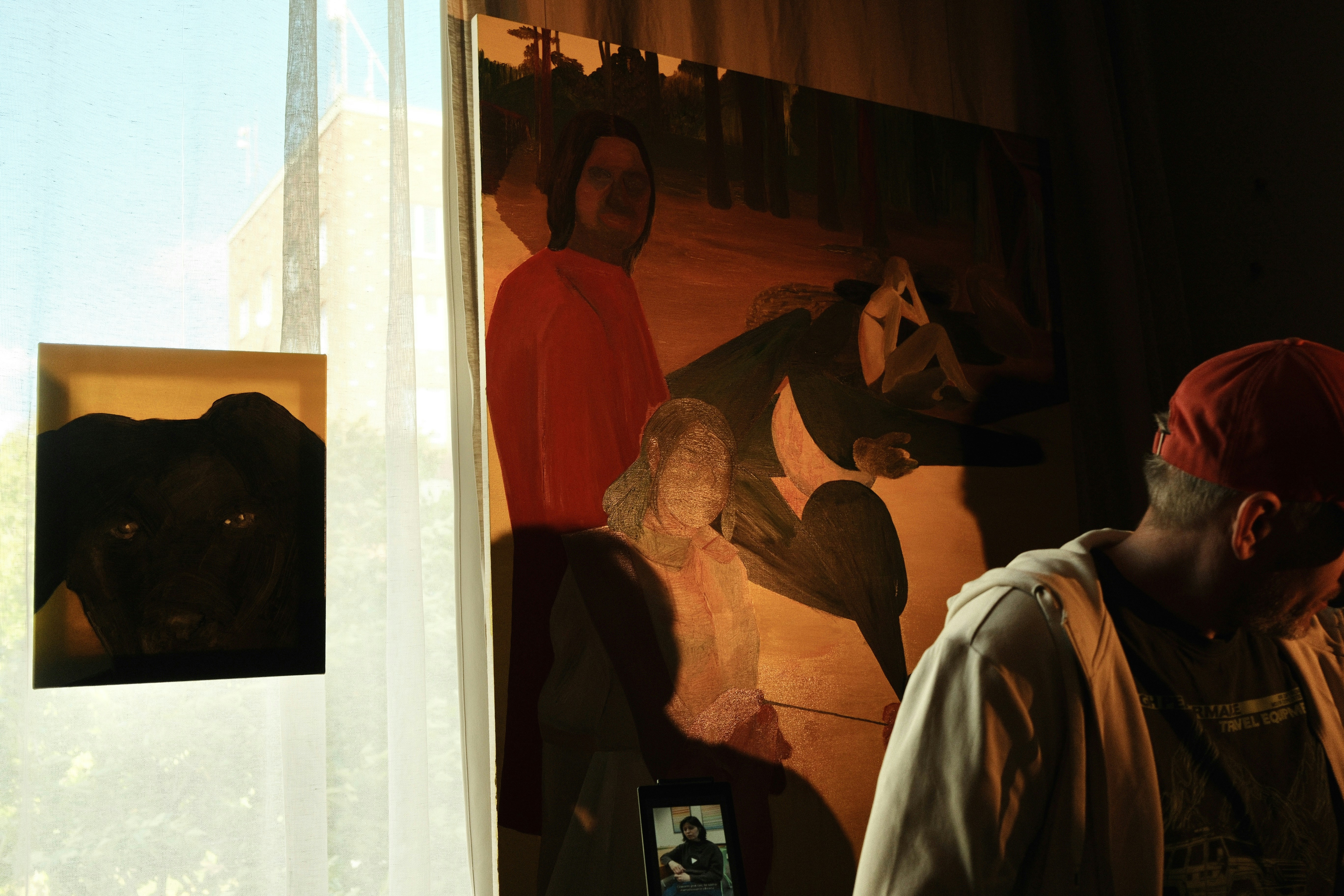 Red-Hued Portraits in a Luminous Gallery Window