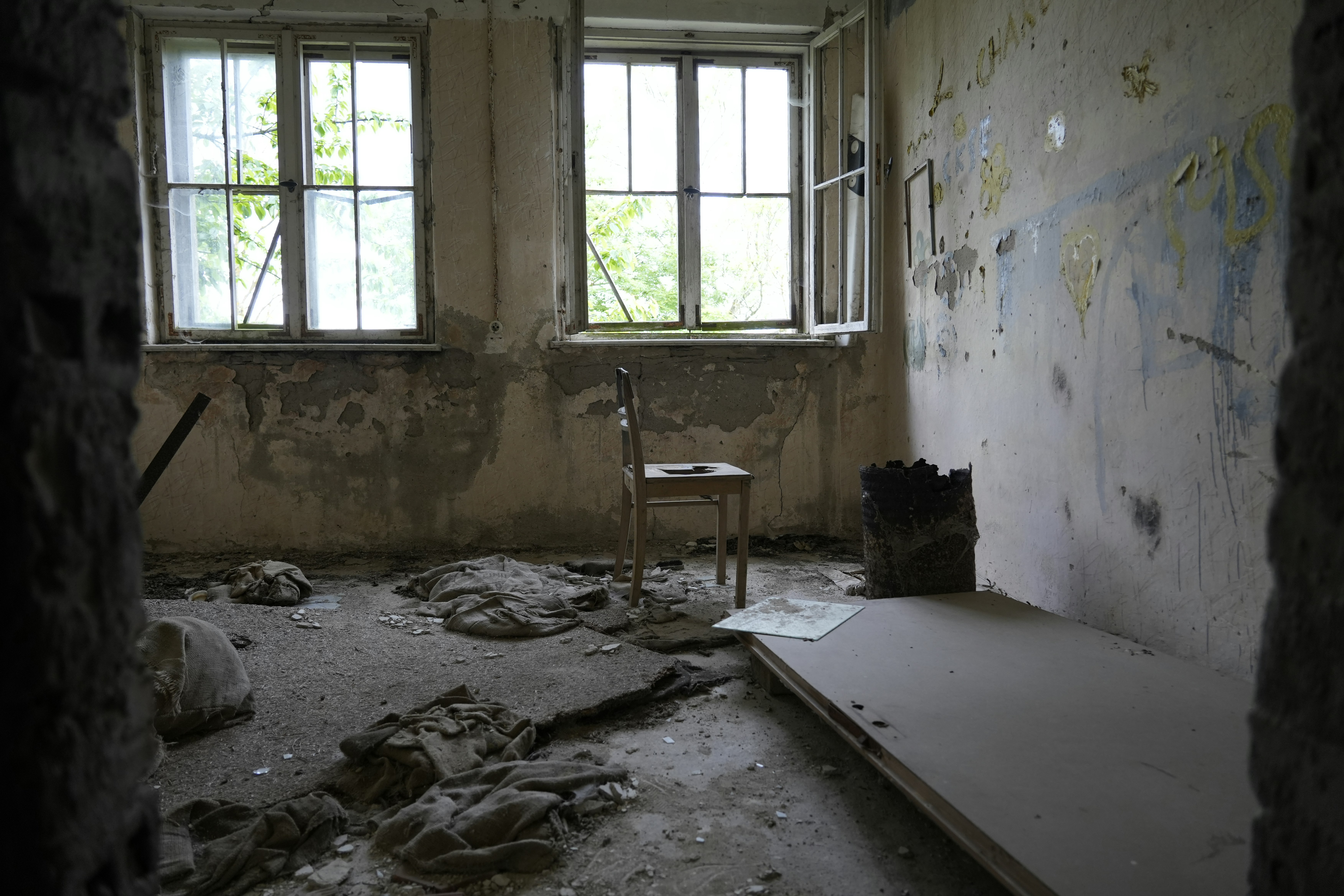 Desolate Dormitory: A Crumbling Room with a Lone Chair