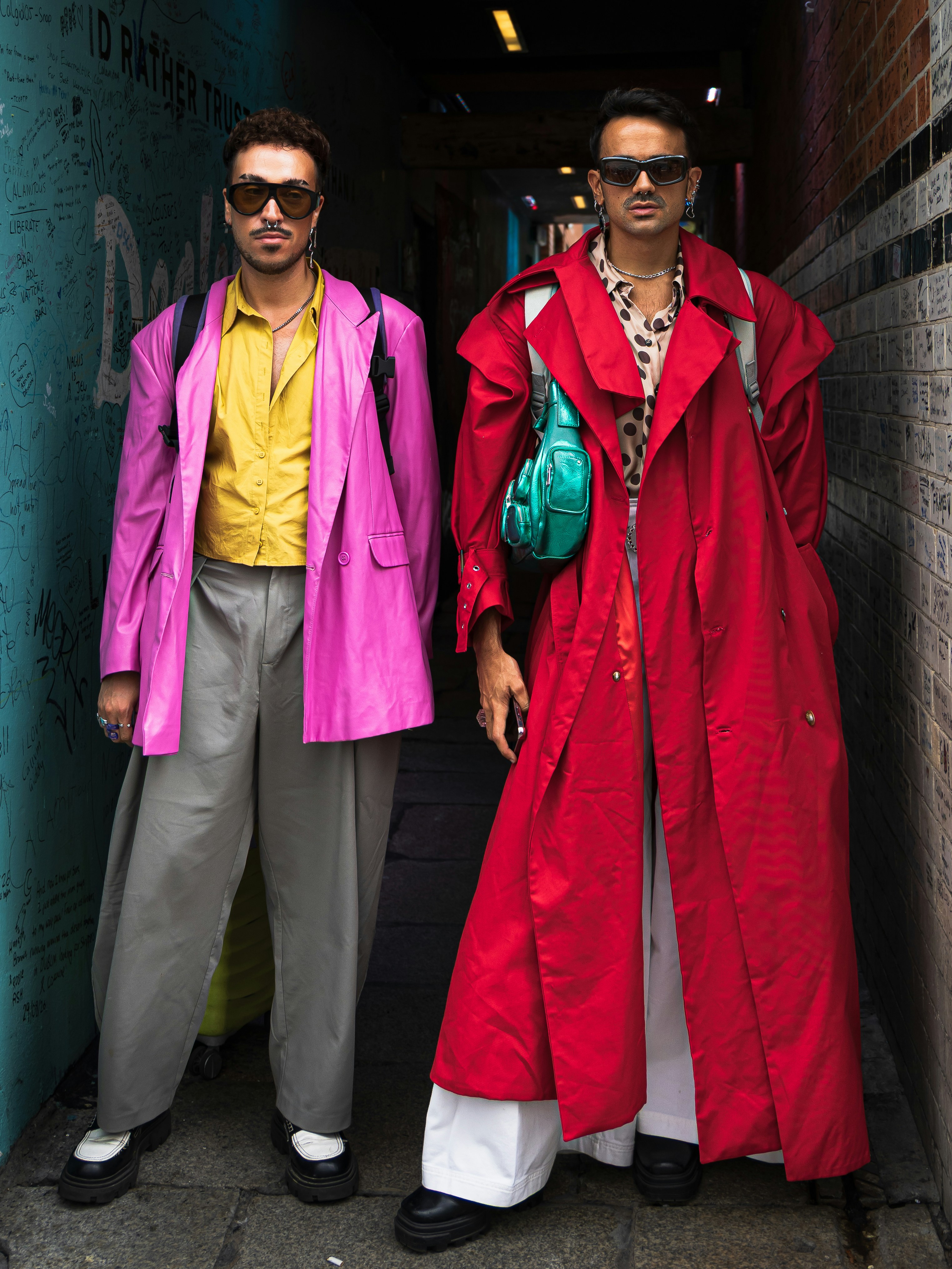 Twin Streets, Bold Threads: Neon Hats and Red Trenchsuits in a Narrow Corridor