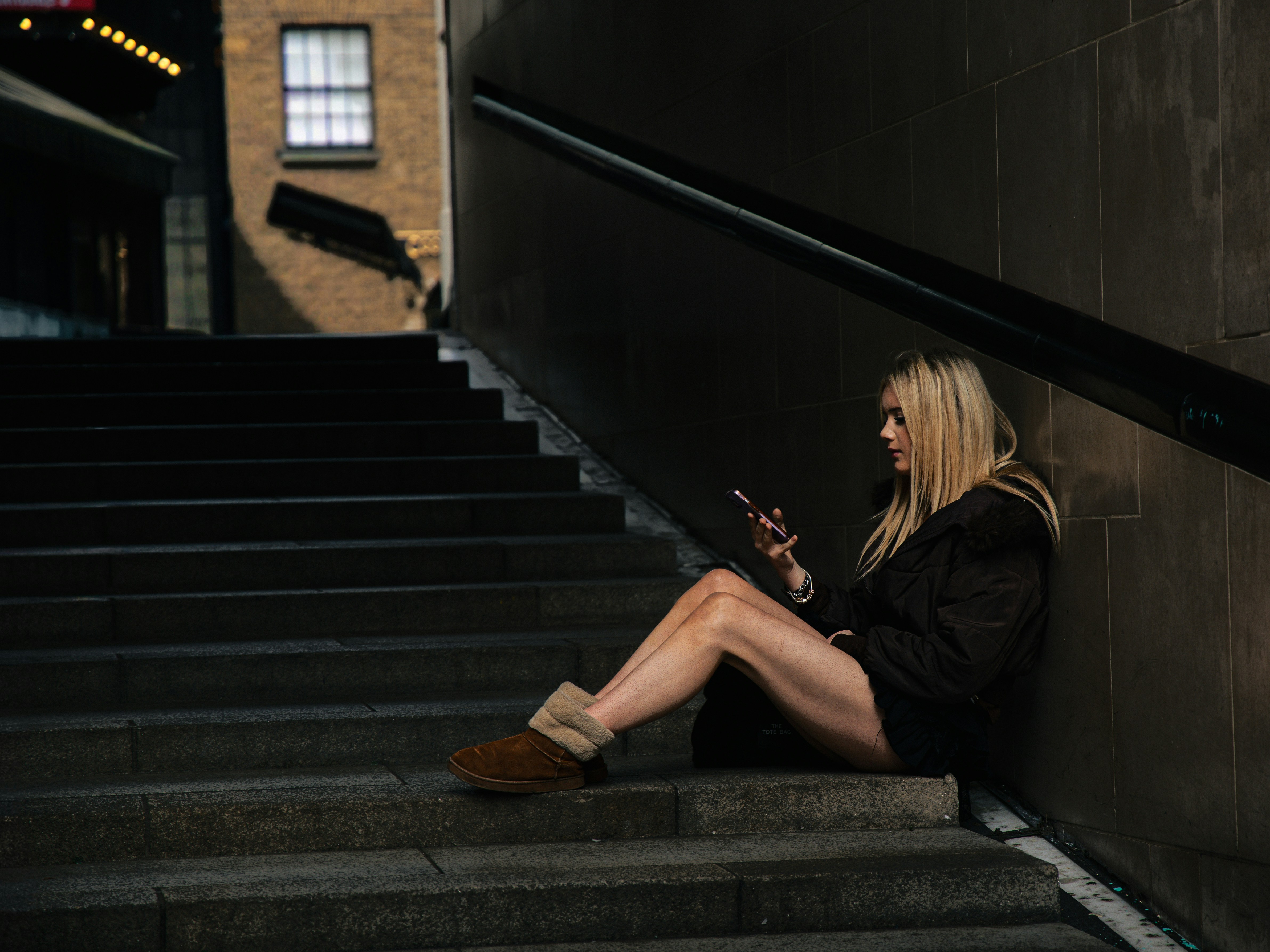 Sidelined in Shadow: A Quiet Moment on the City Steps
