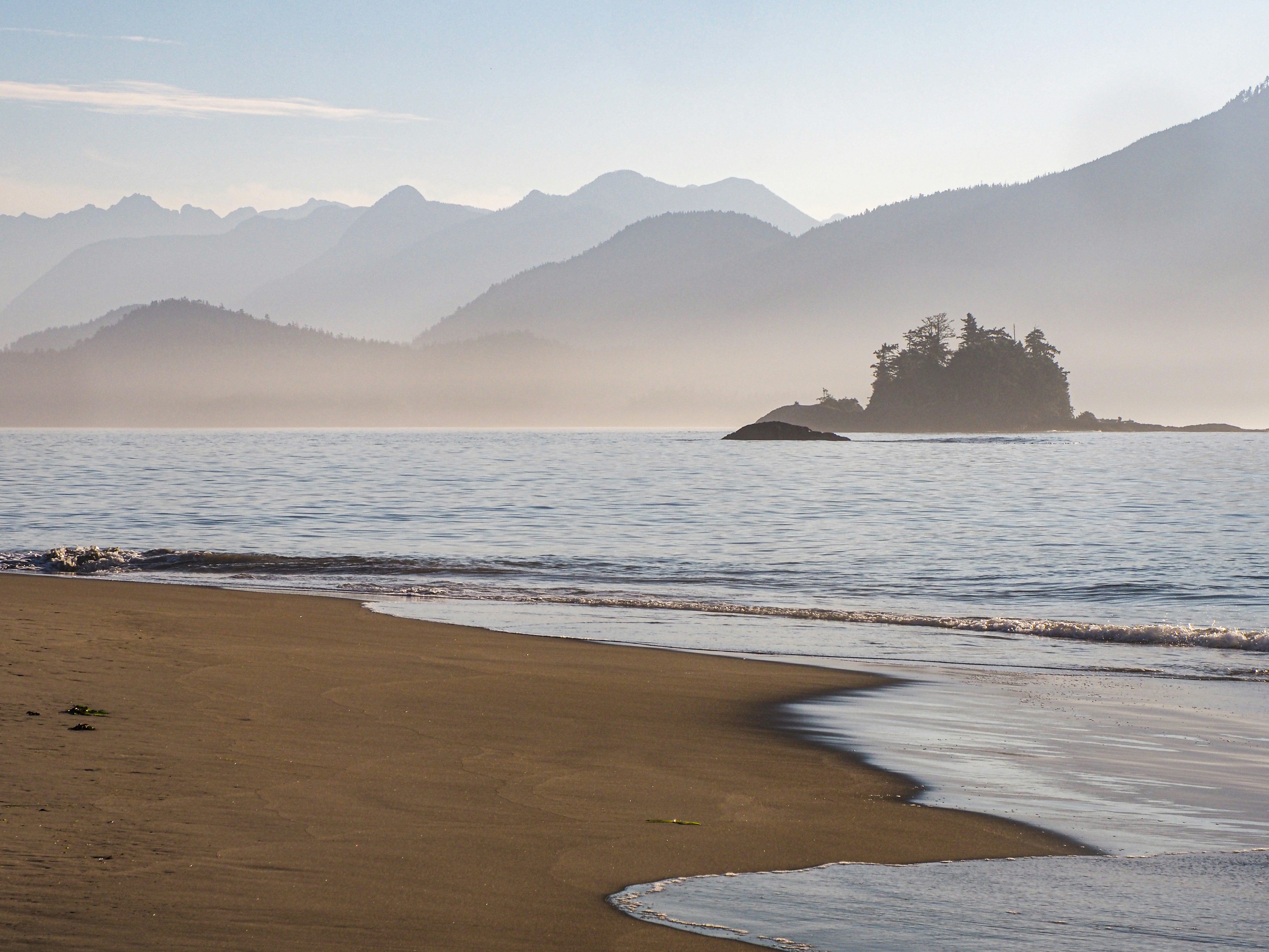 Mist over the Island: Silent shoreline beneath fading mountains
