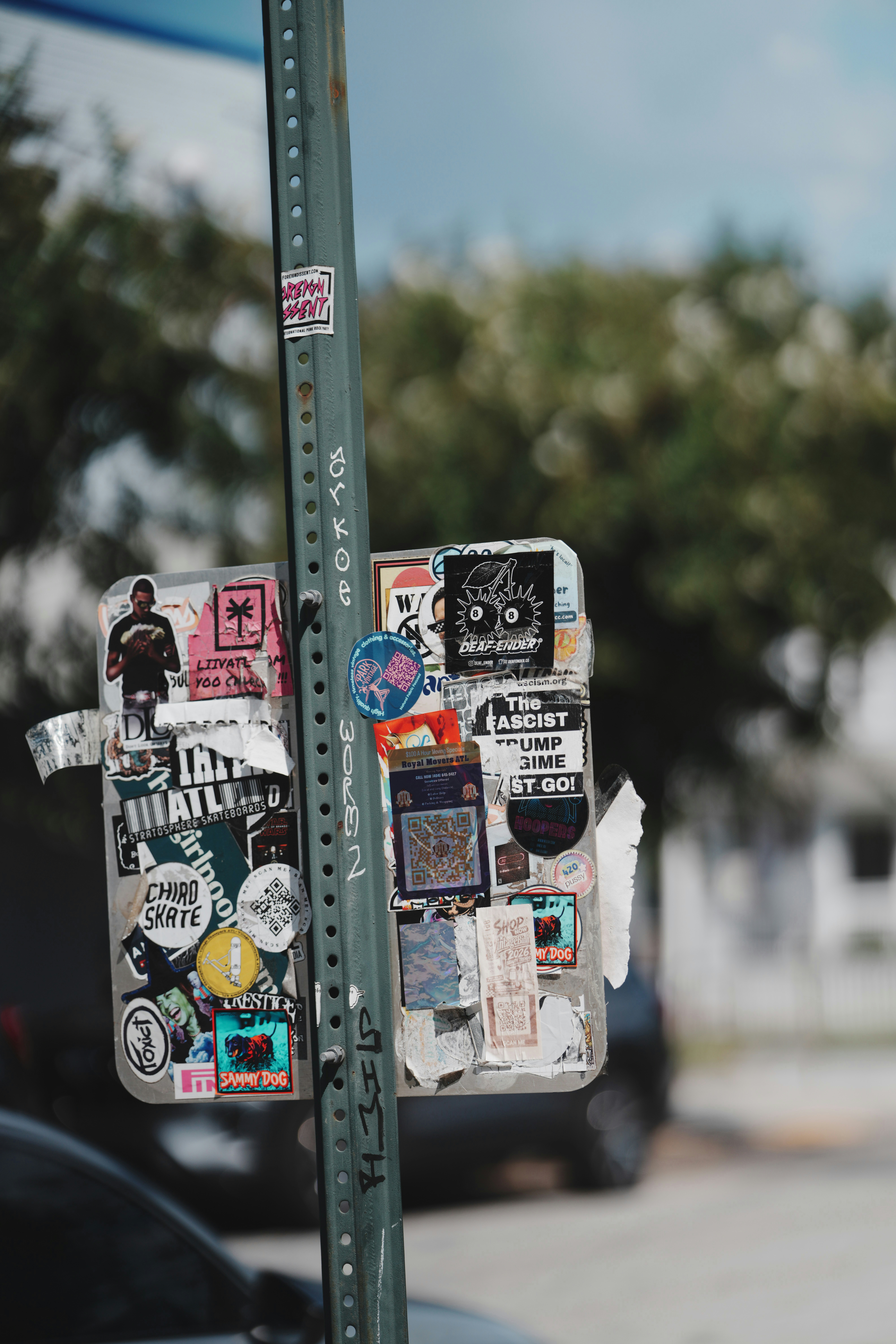 Stickered Pole: A Urban Collage on a Metal Street Pole
