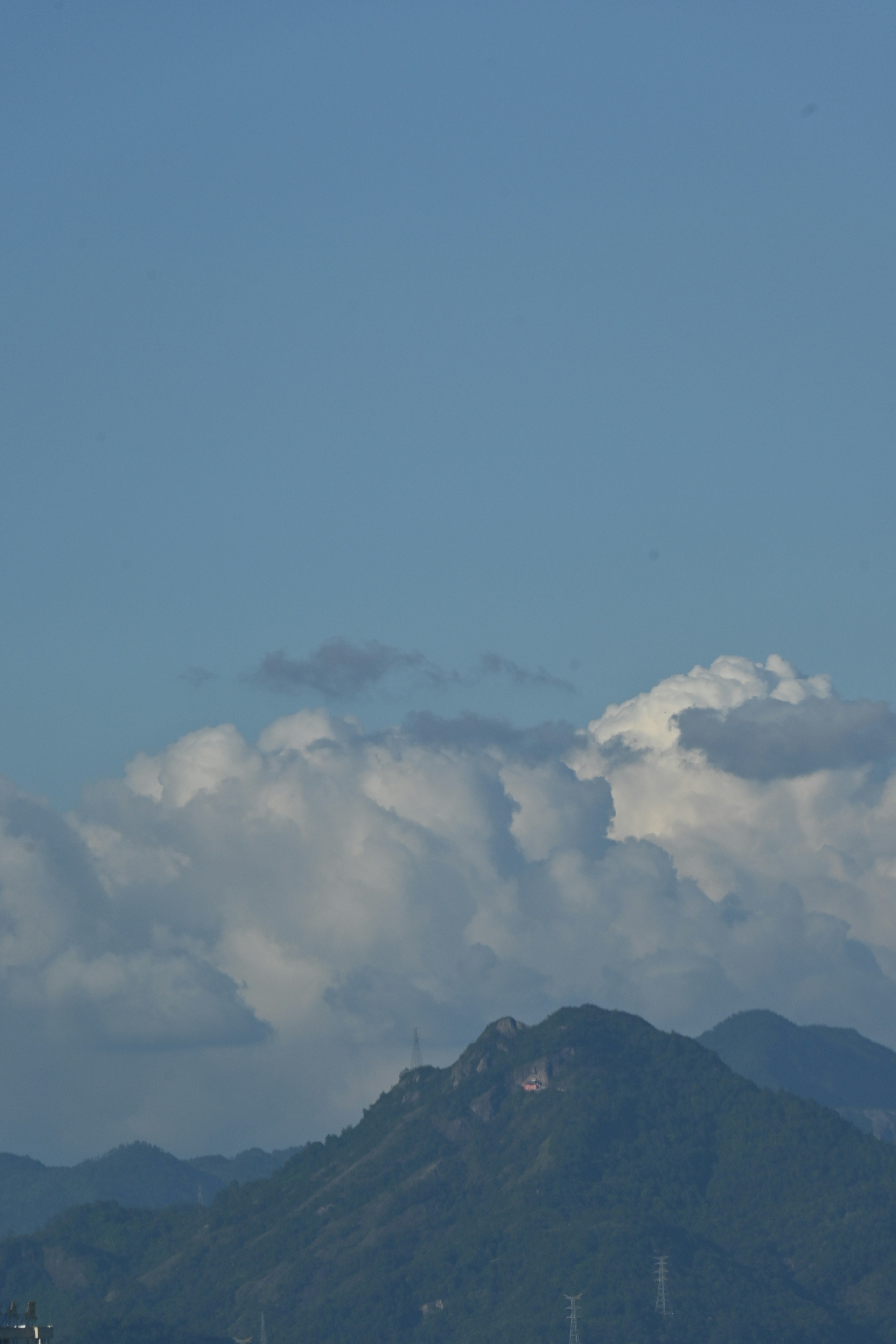 Cloudscape over distant ridges: quiet sky meets mountain silhouette
