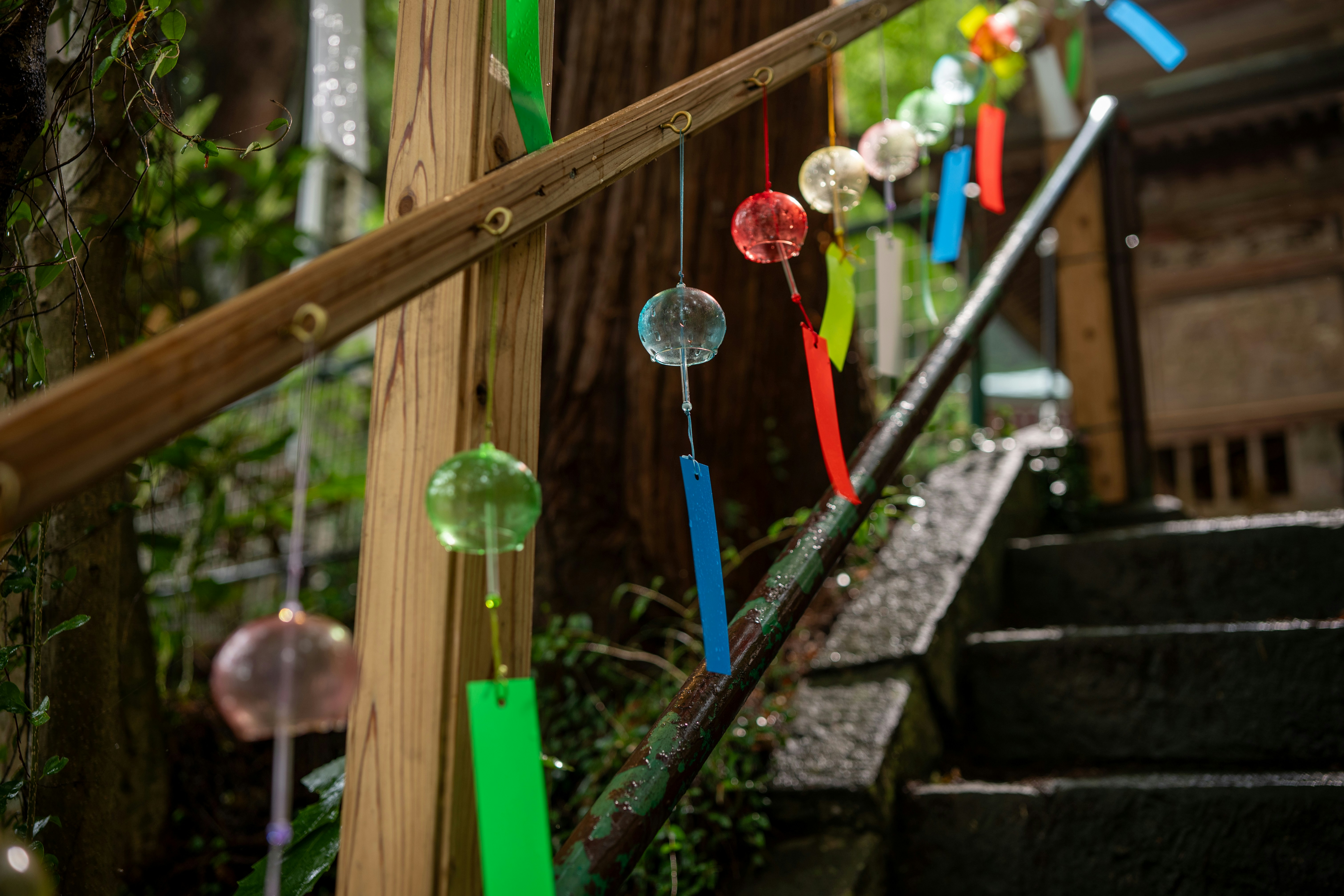 Colorful Prayer Strings on a Wooden Handrail in a Shrine Staircase