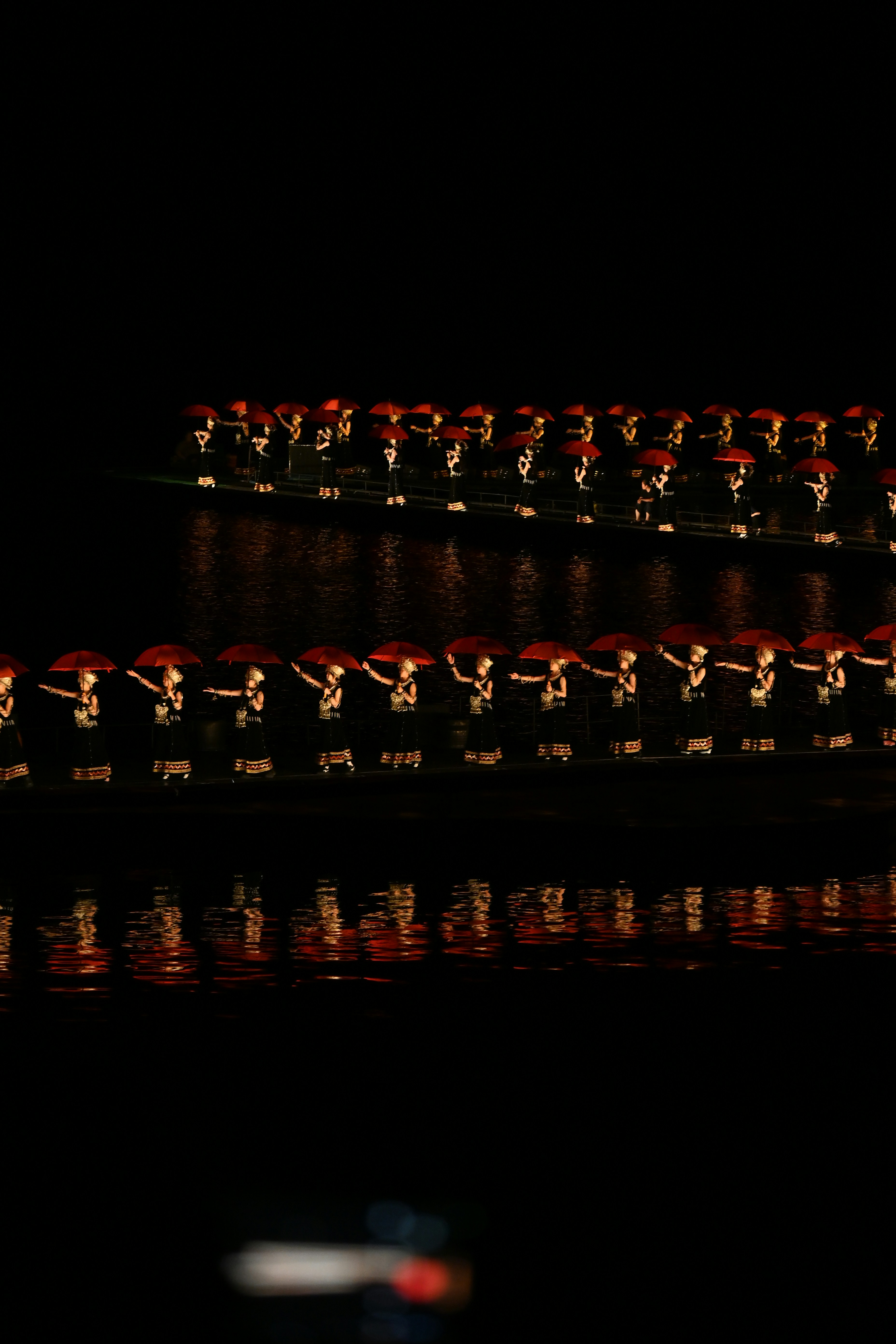 Red-umbrella line on dark water