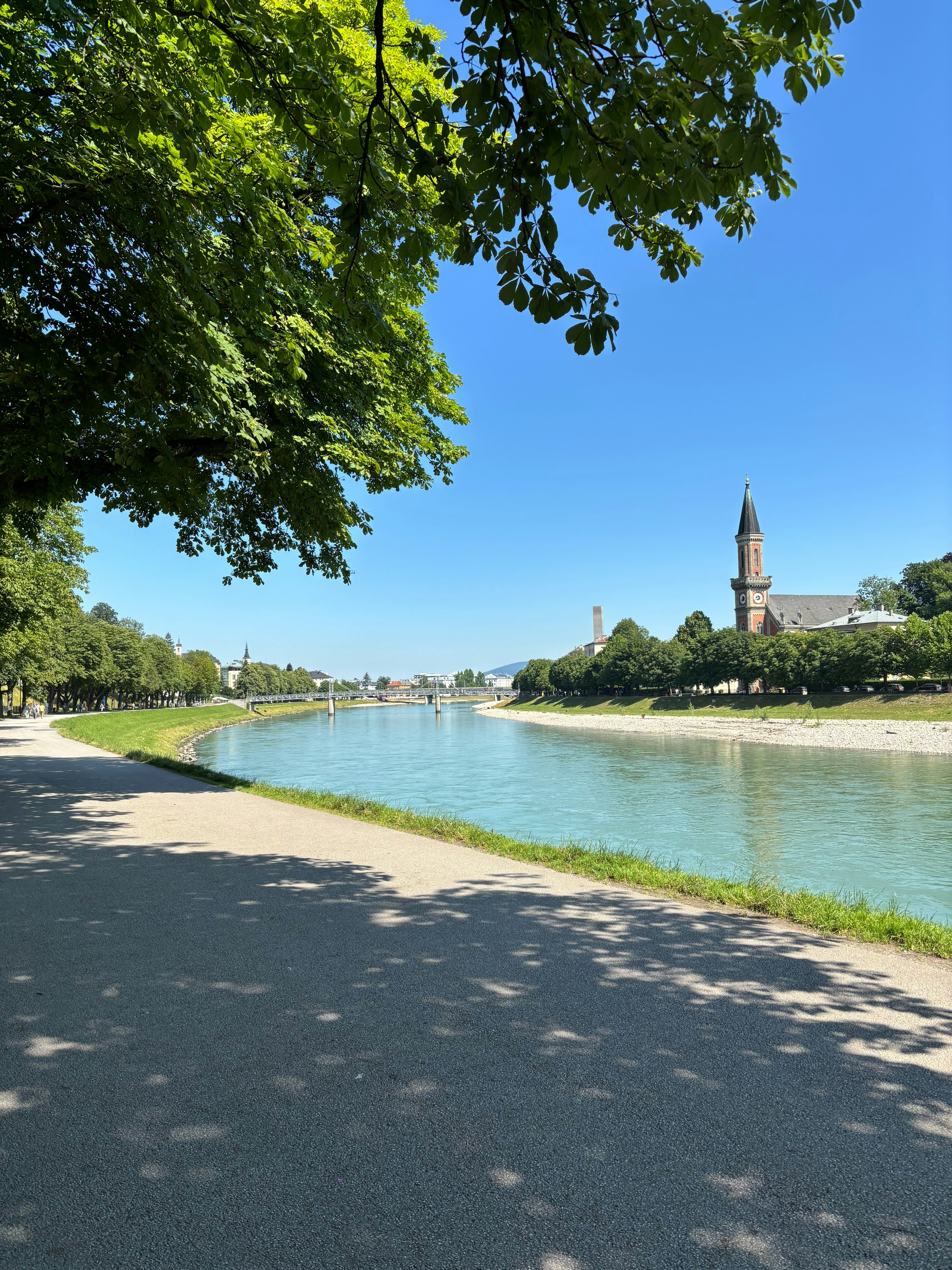 Shoreline Promenade with Cathedral Spire Under a Clear Sky