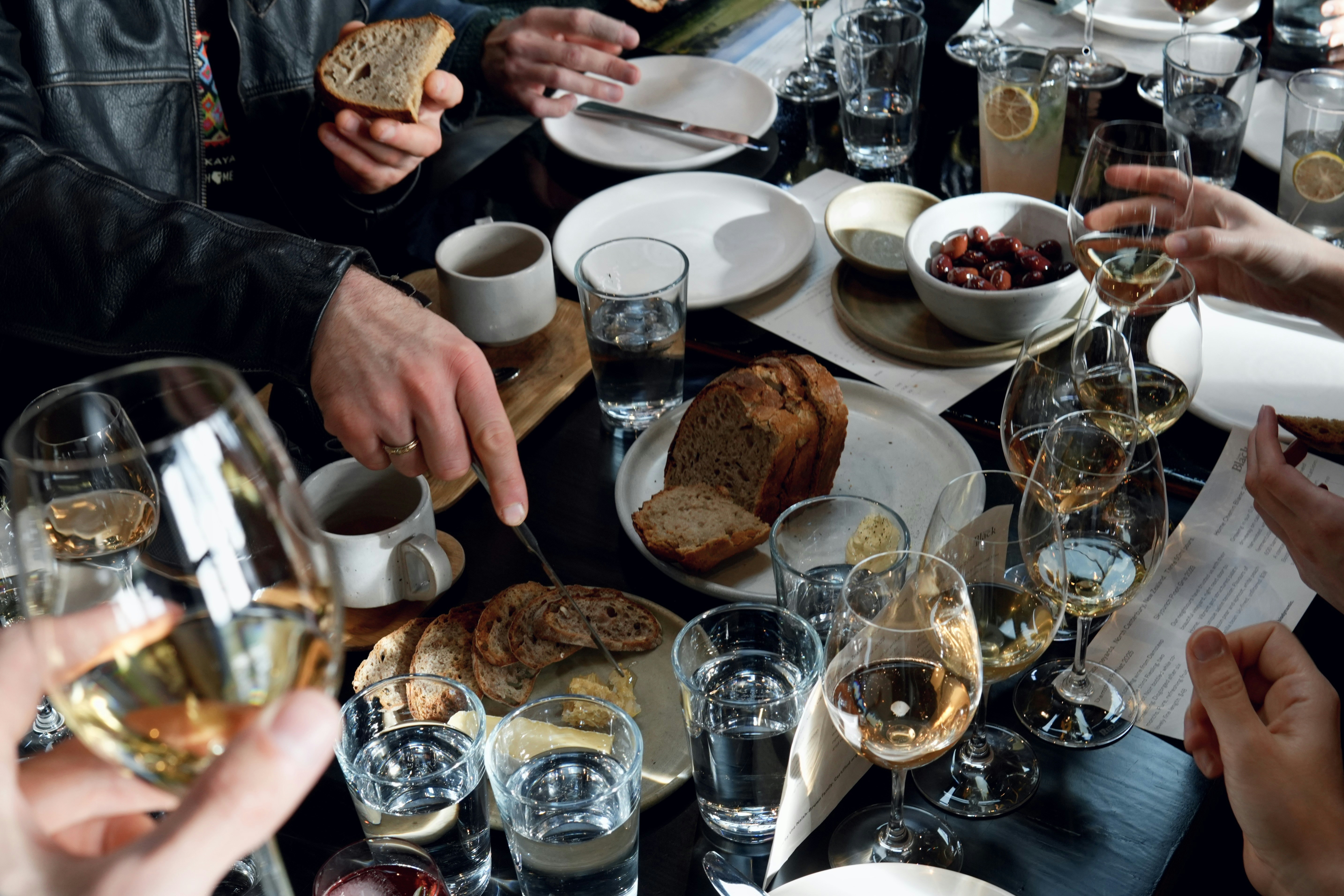 Toast Toasts and Shared Moments Around a Bread-Laden Table