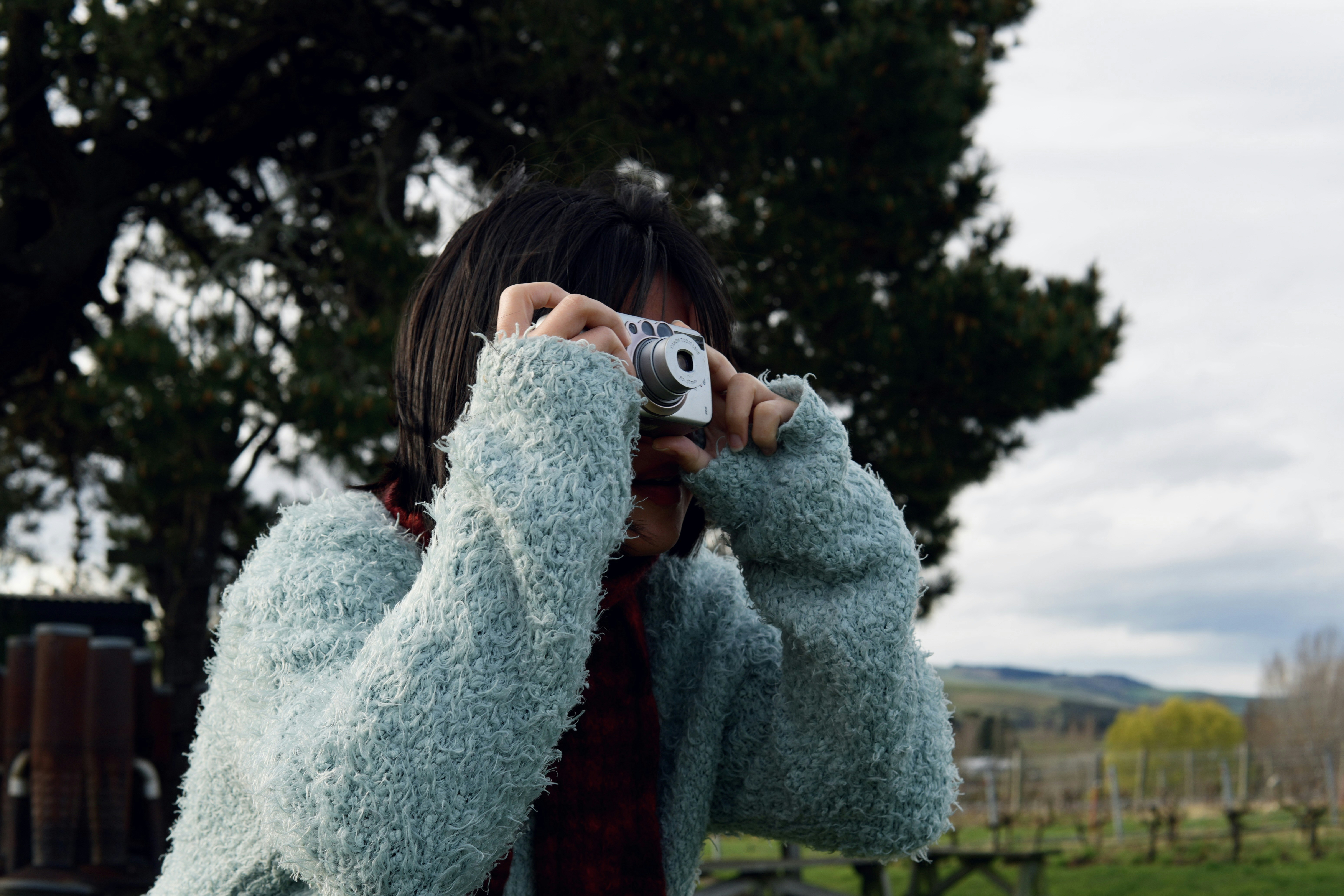 Portrait in a Cozy Blur: A Photographer in a Turquoise Embrace