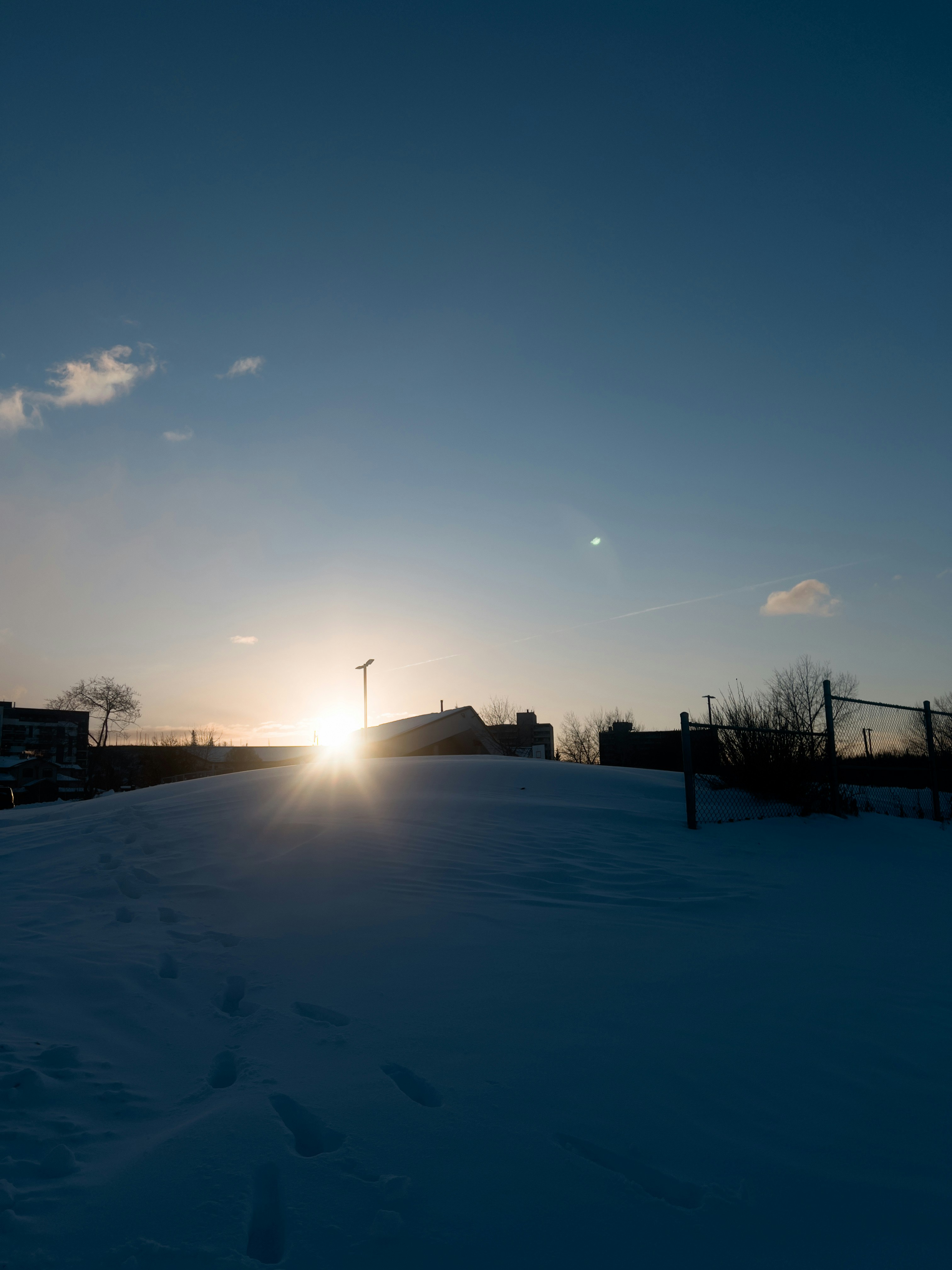 Sunlit Horizon Over Snow: Quiet Rural Dawn
