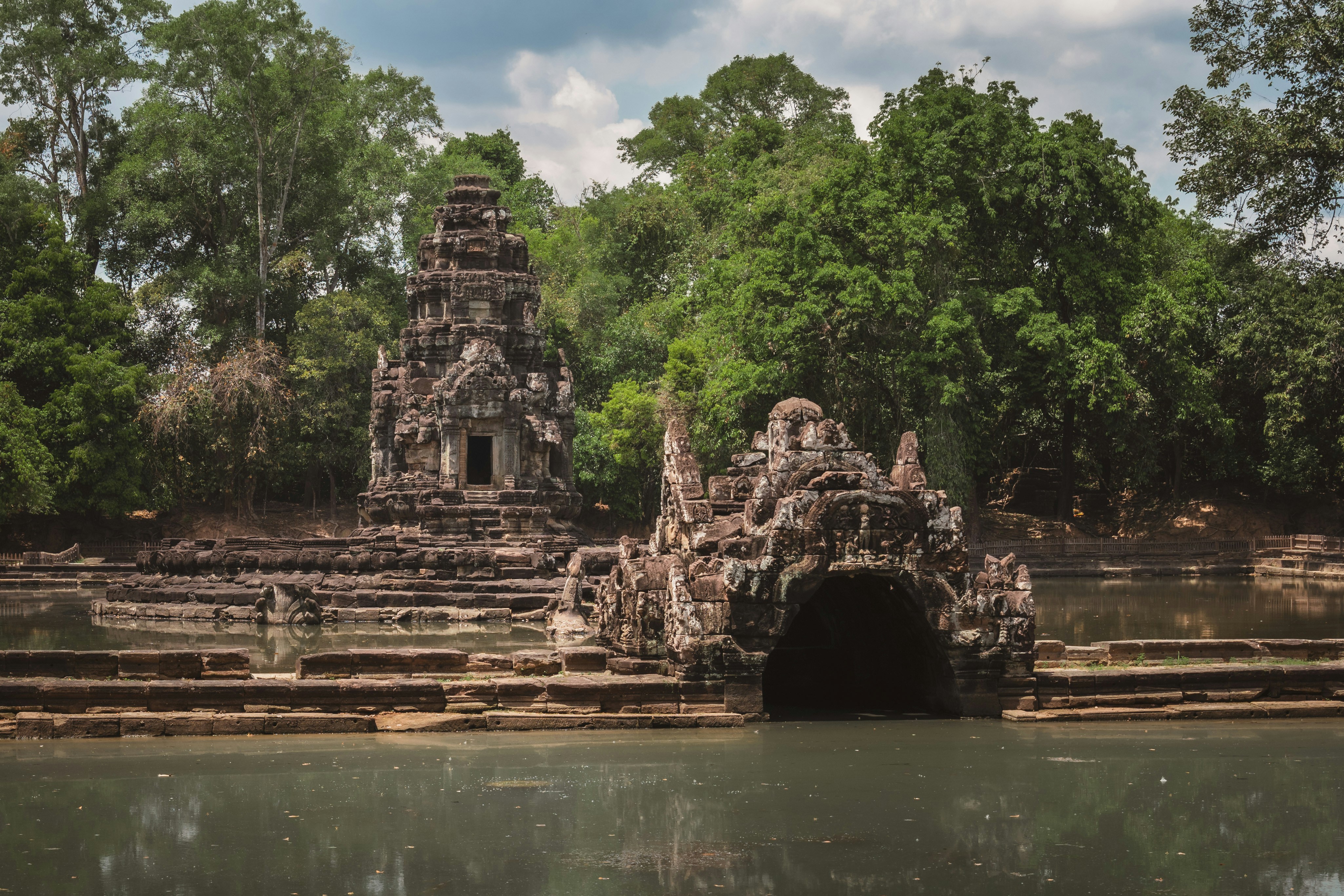 Ancient Stone Gate Emerging from Quiet Pool
