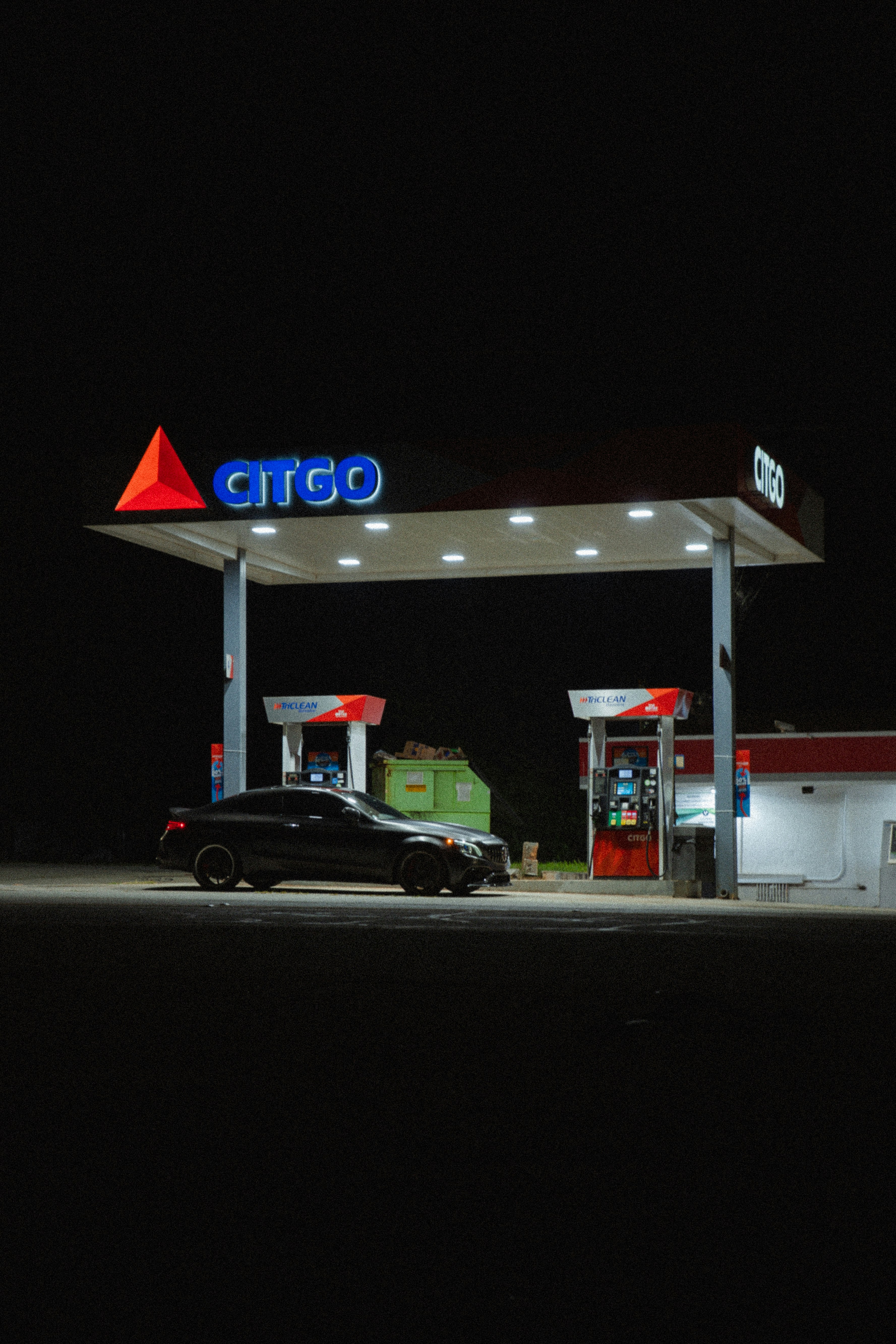 Midnight Pit Stop: Neon Signage and Night Illumination at a Quiet Gas Station