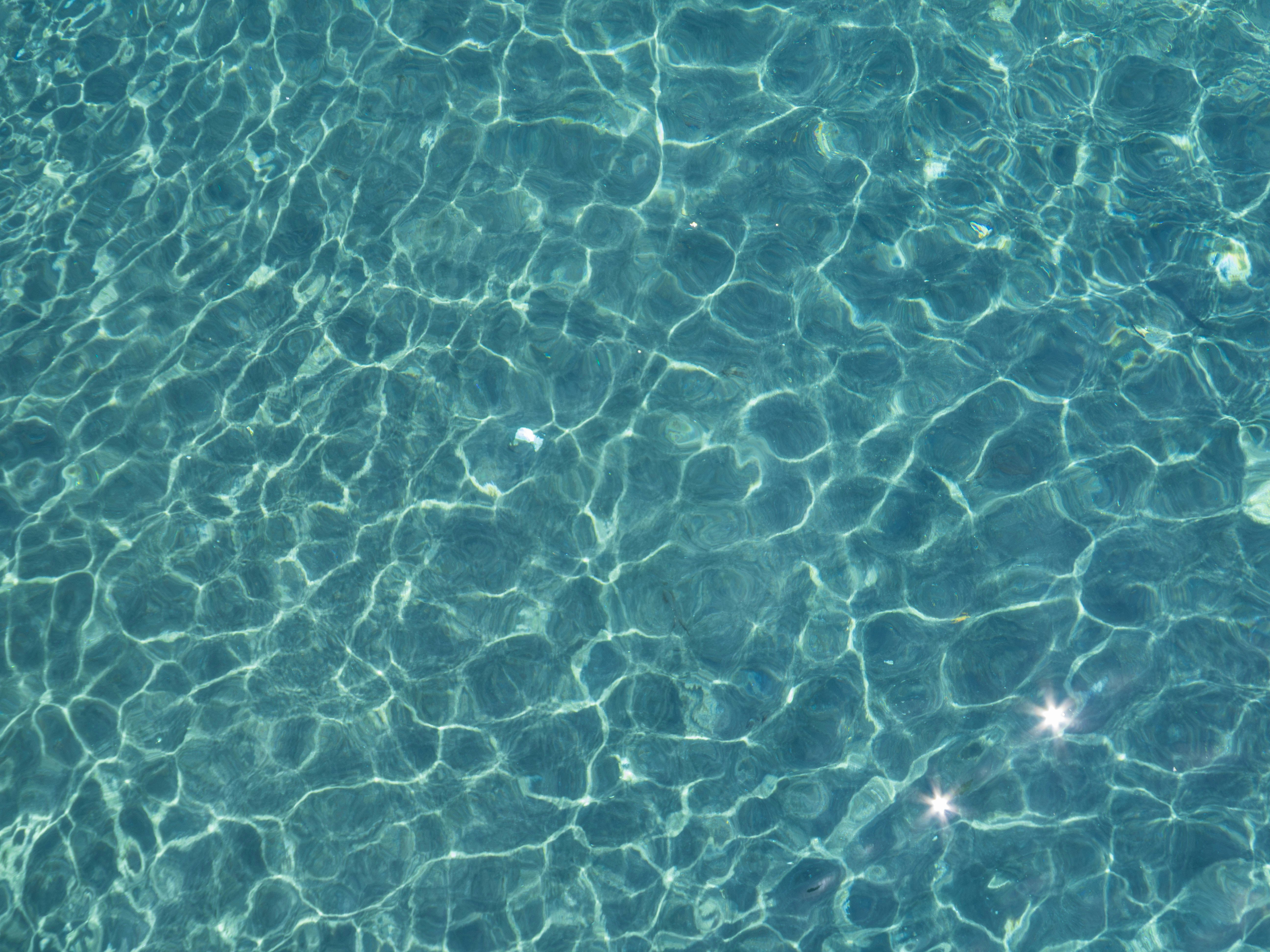 Sunlit Ripples: A Teal Sea Whispering Light