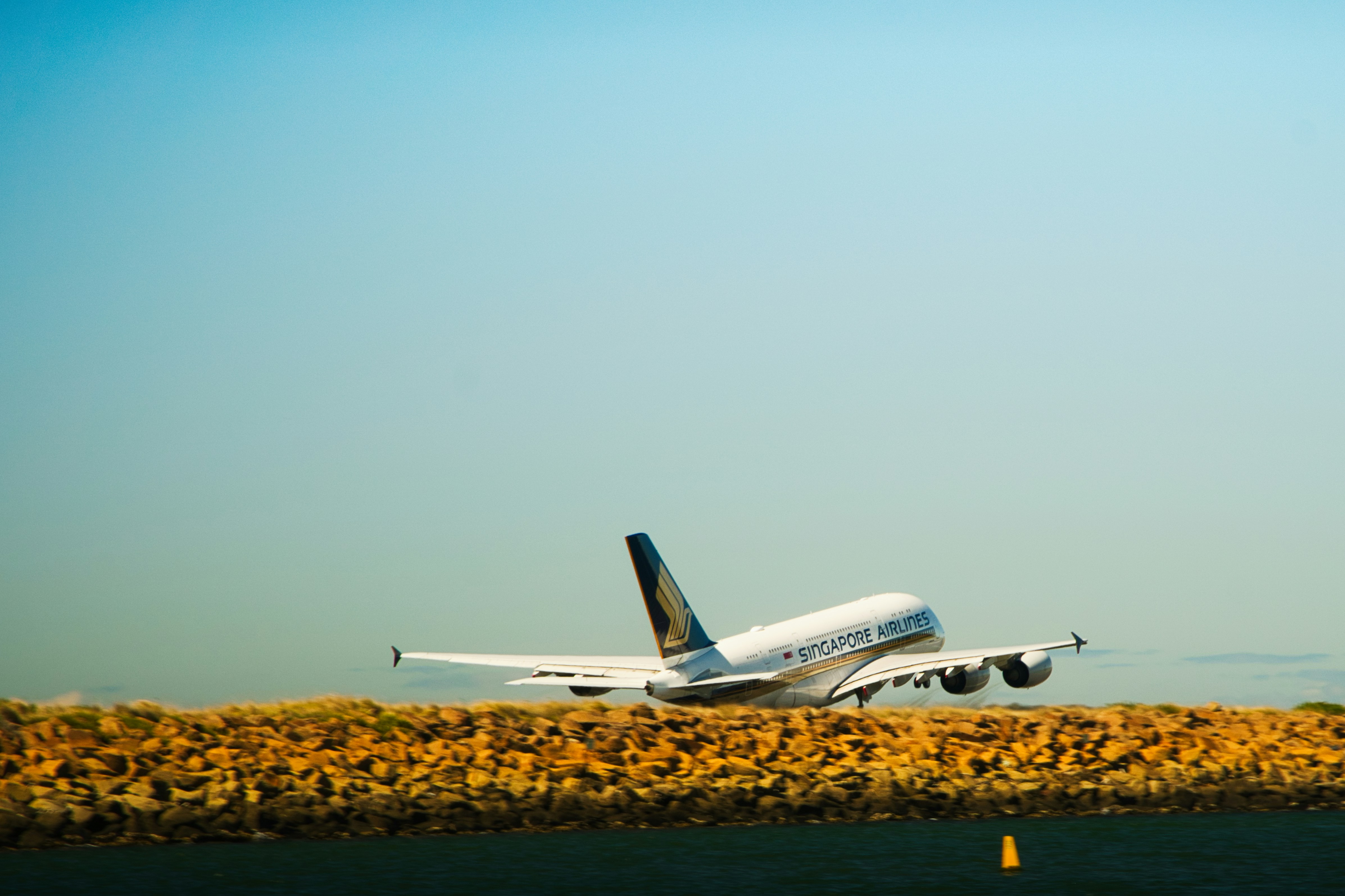Golden Ridge Takeoff: Singapore Airlines A380 Pierces a Clear Horizon