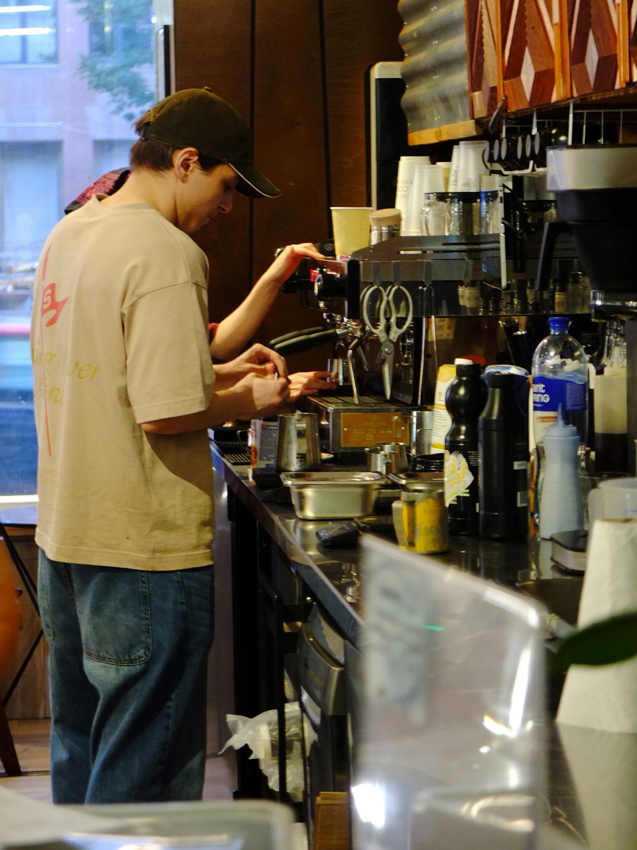 Brewing Focus: Barista at Work Behind the Espresso Station