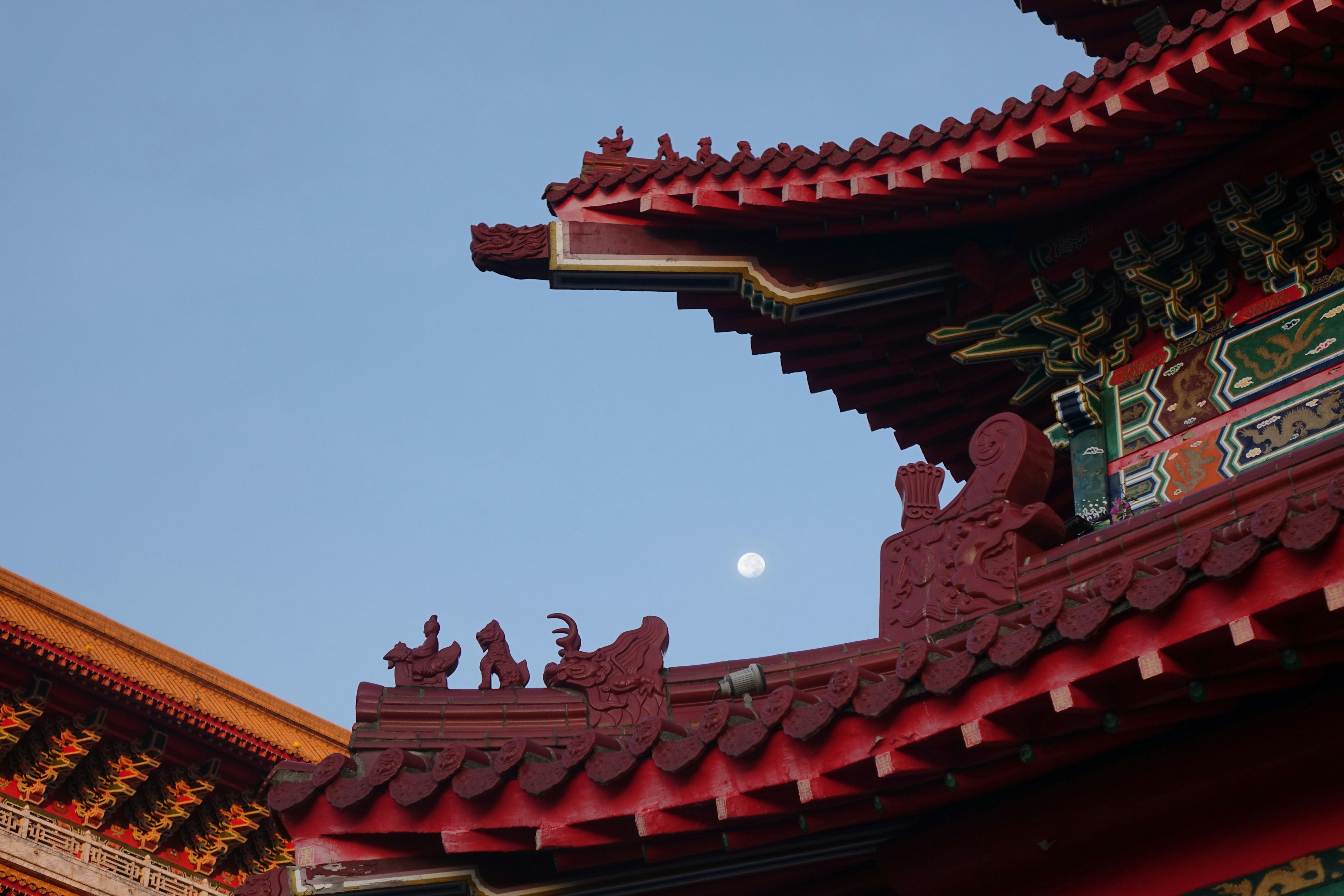 Moonlit Roofline: A Red Corner of Zen and Sky