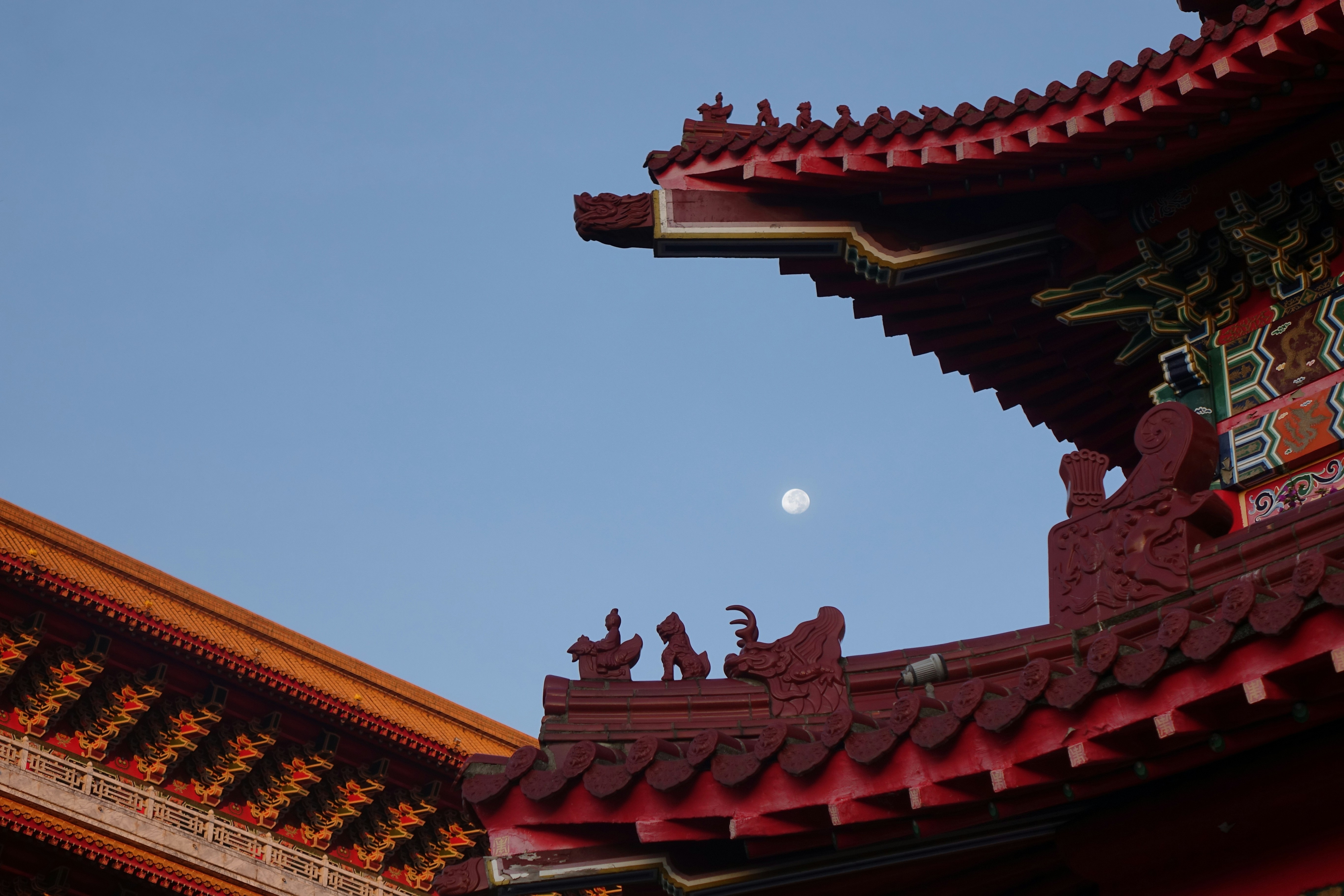 Moonlit Rooflines: Red Temples under a Quiet Sky