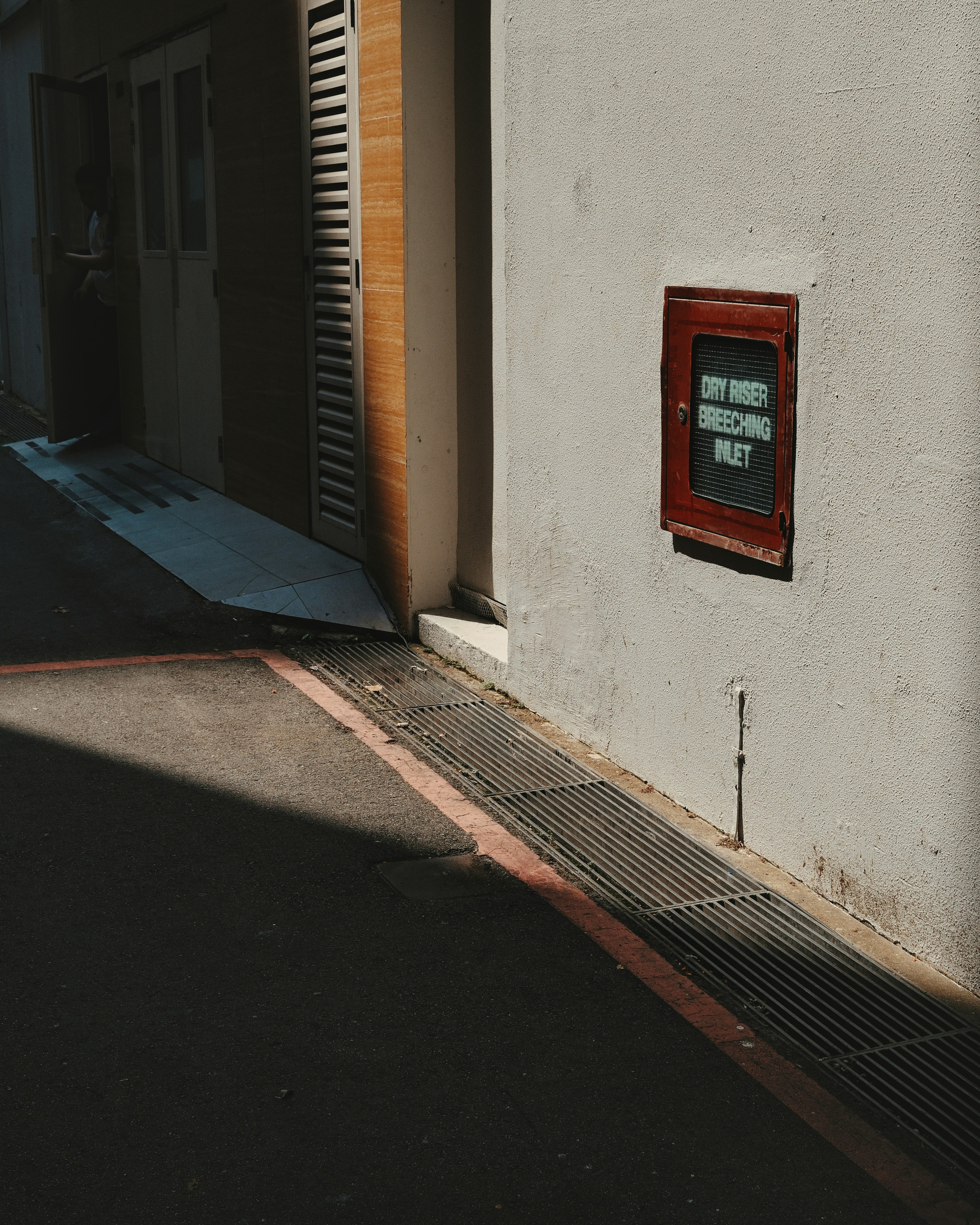 Shadowed Alley Encounter by a Wall-Mill Stone Vent