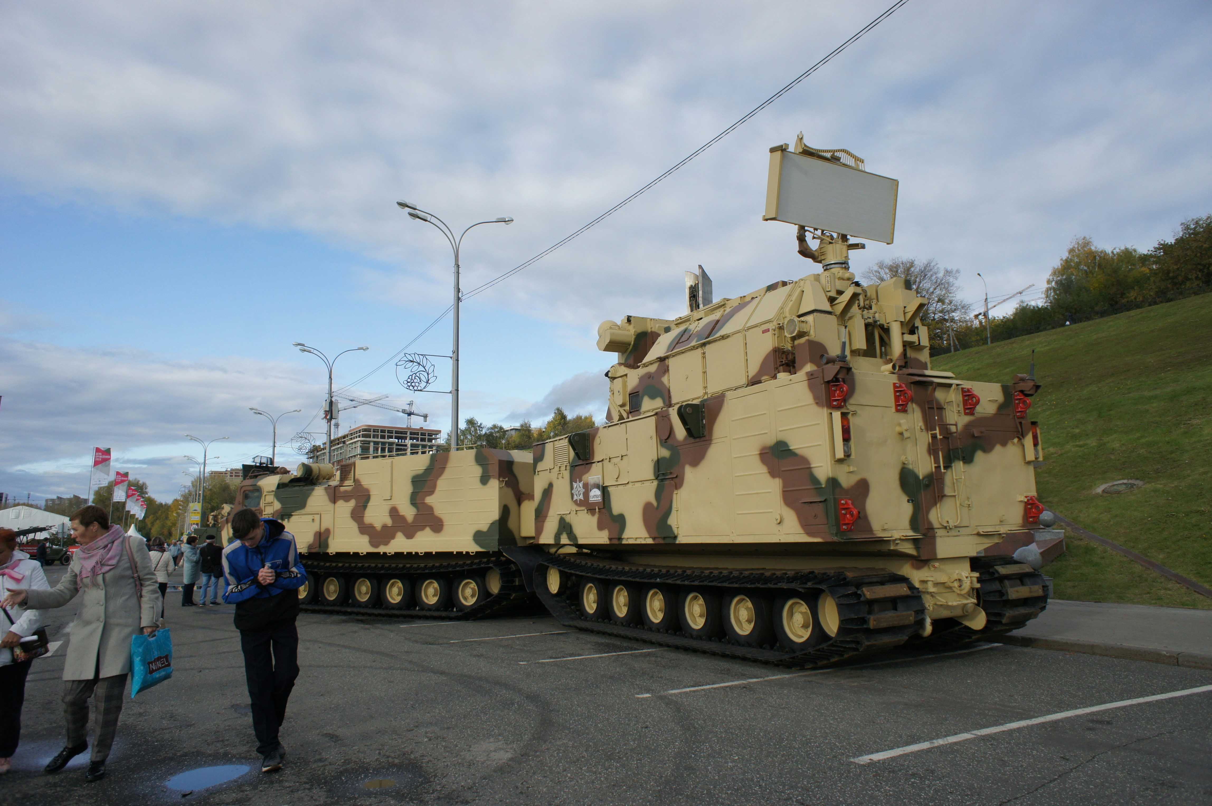 Desert Camouflage: A Tank Convoy in an Urban Plaza