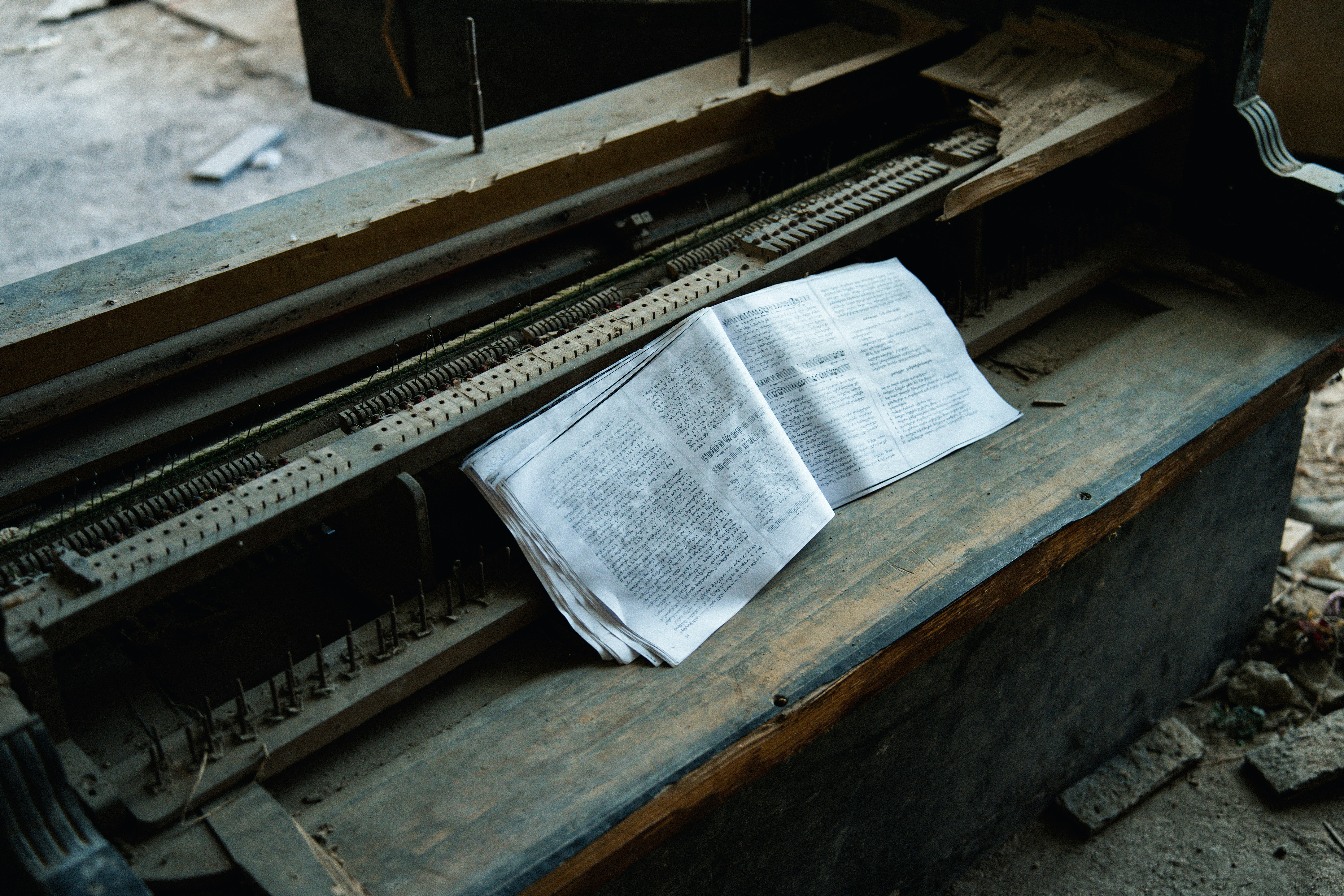 Dusty Piano Keyboard Revealed with a Folded Newspaper