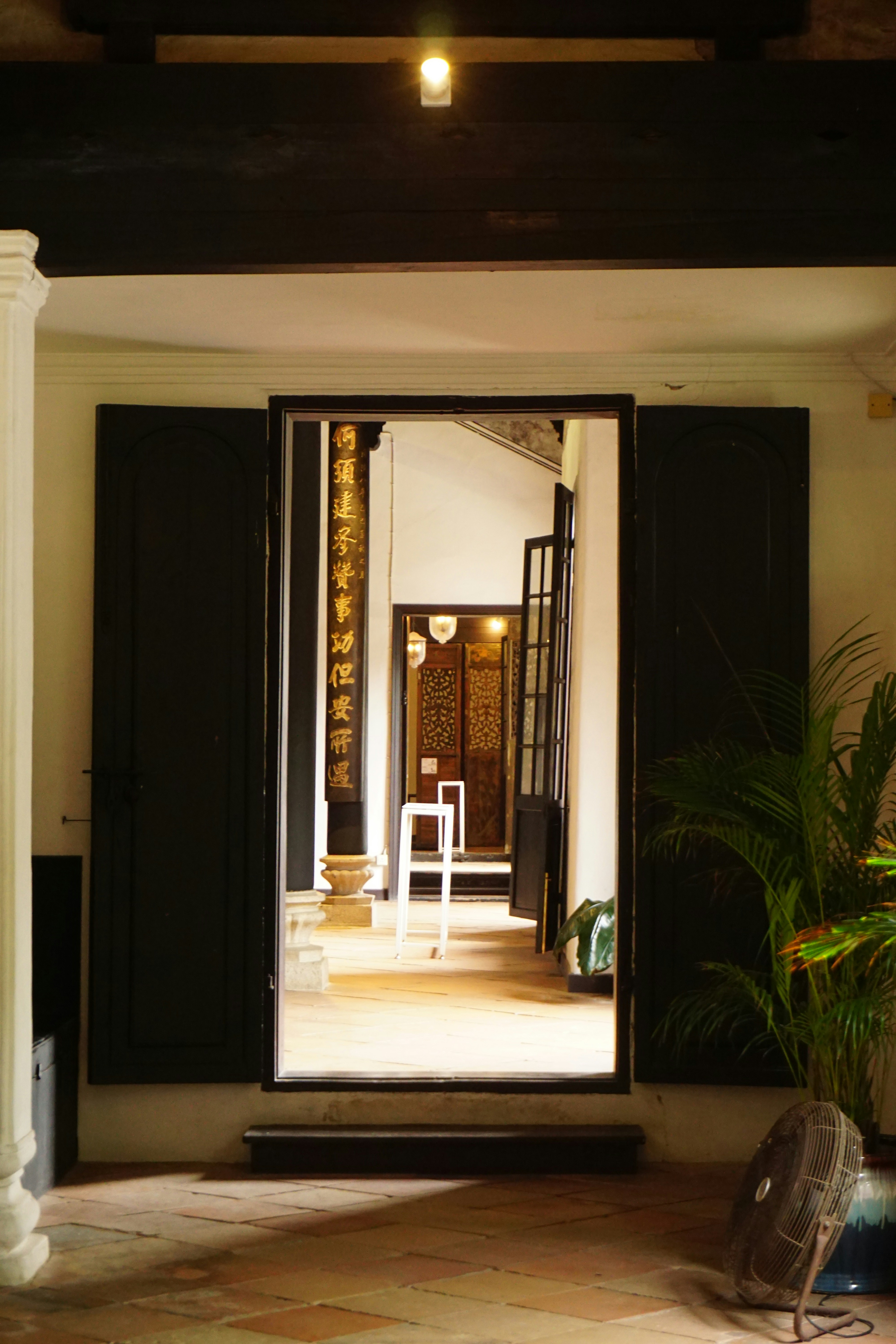 Doorway to a Quiet Gallery: lanterns, frames, and a receding interior