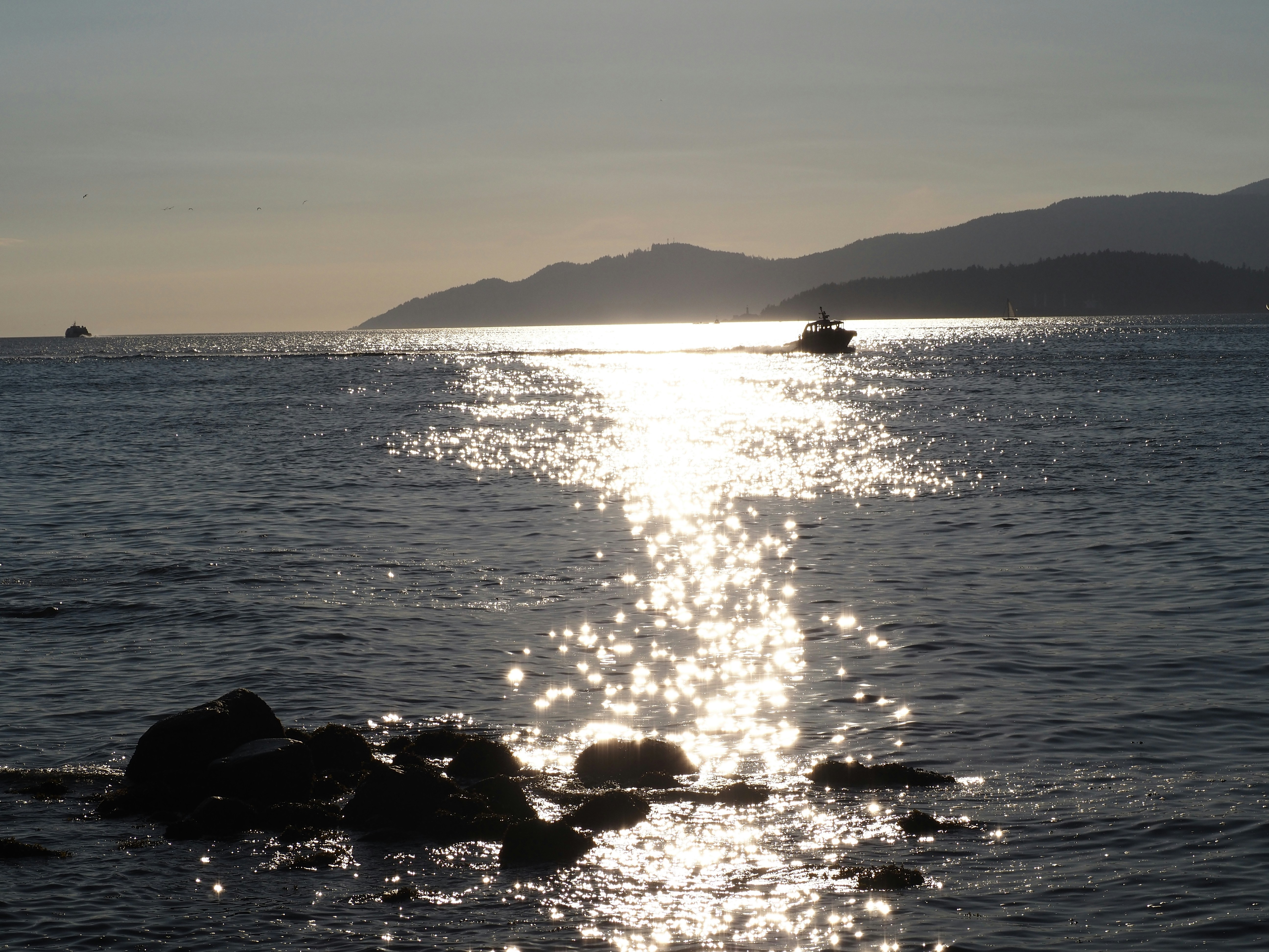 Glittering Sea Pass with Distant Boat