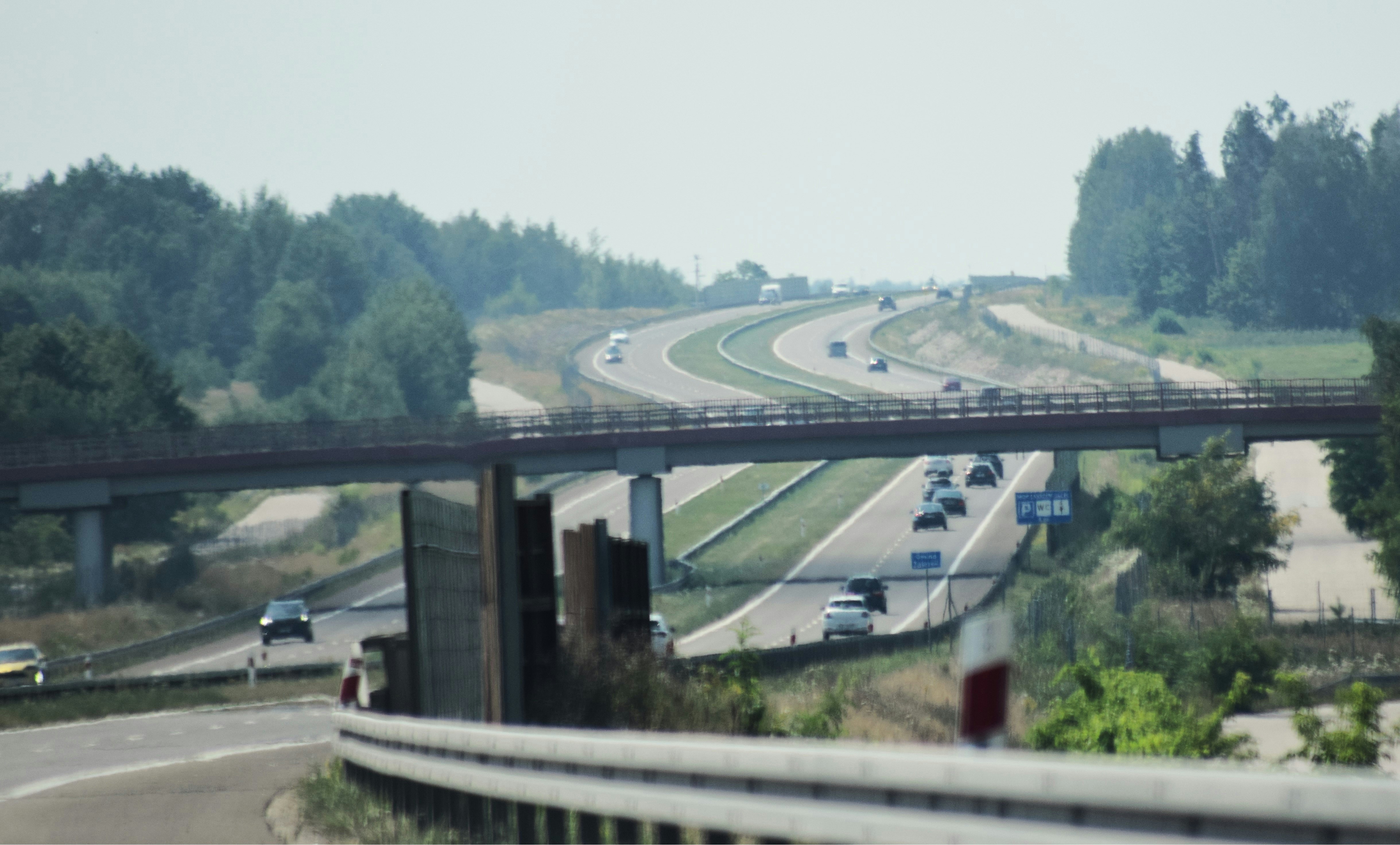 Overpass Vista: A Quiet Stretch of Highway Bends Beneath a Rural Sky