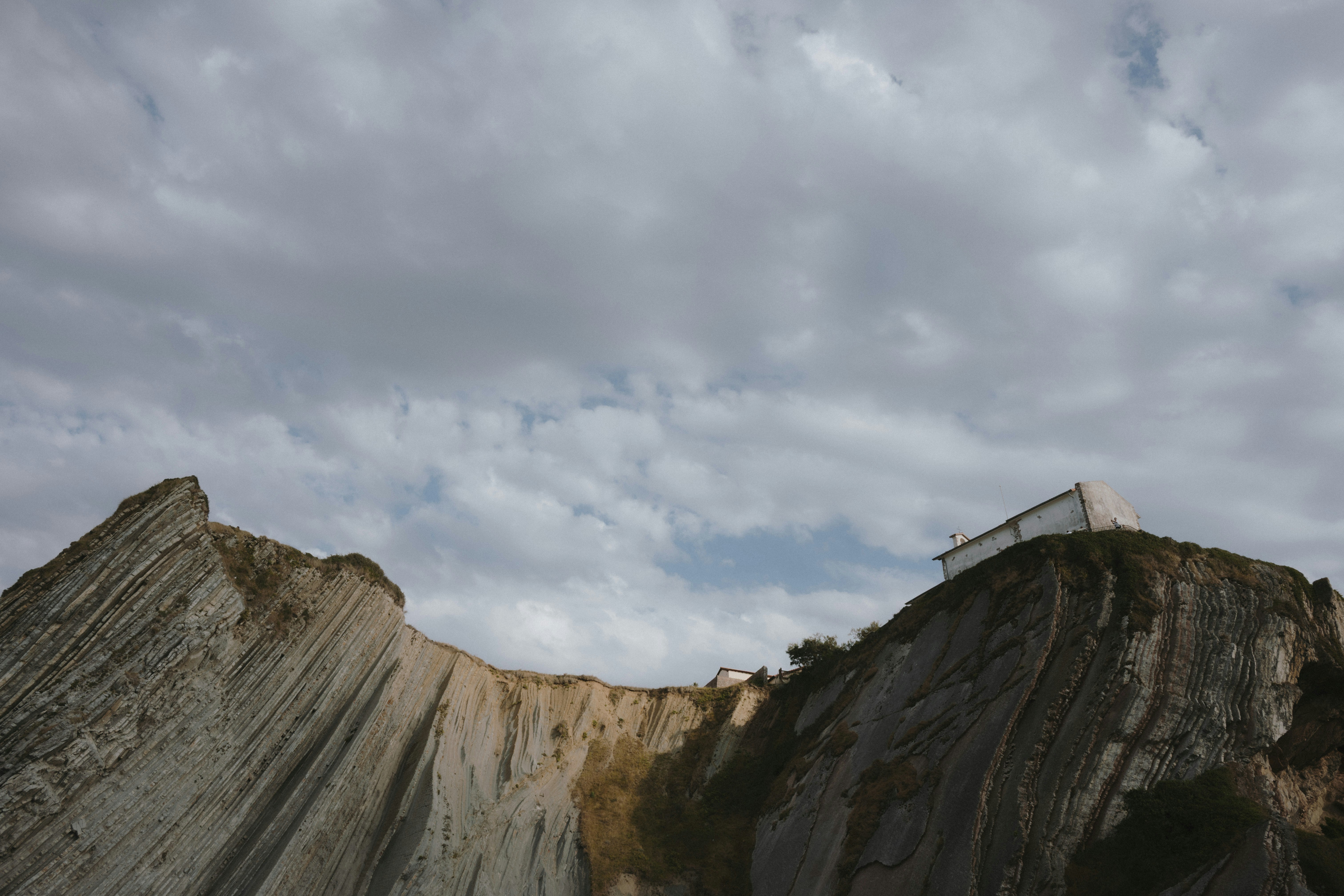 Cliff Edge Watchtower Under Wide Sky