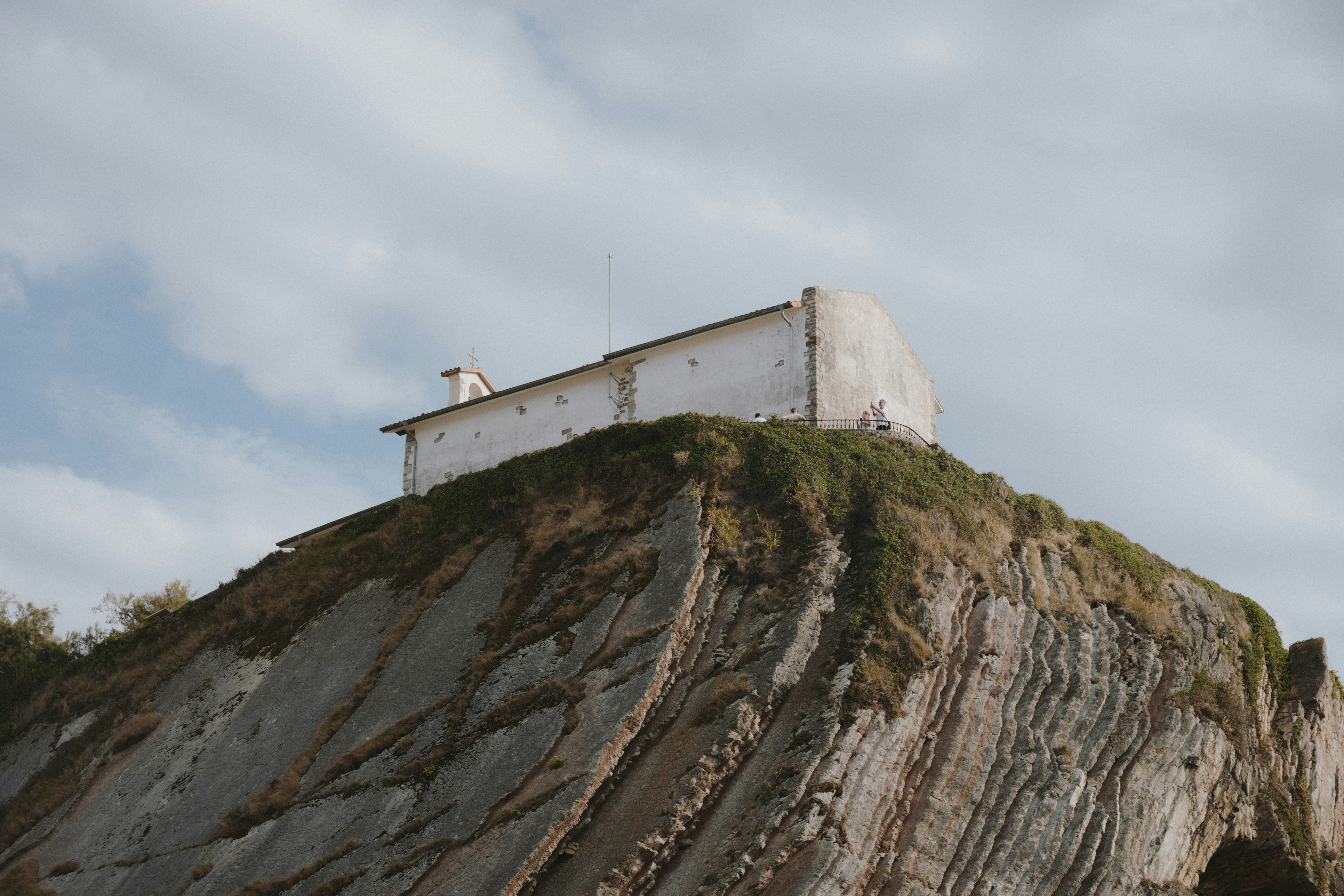 A weathered cliff-top outpost watched over by shifting skies