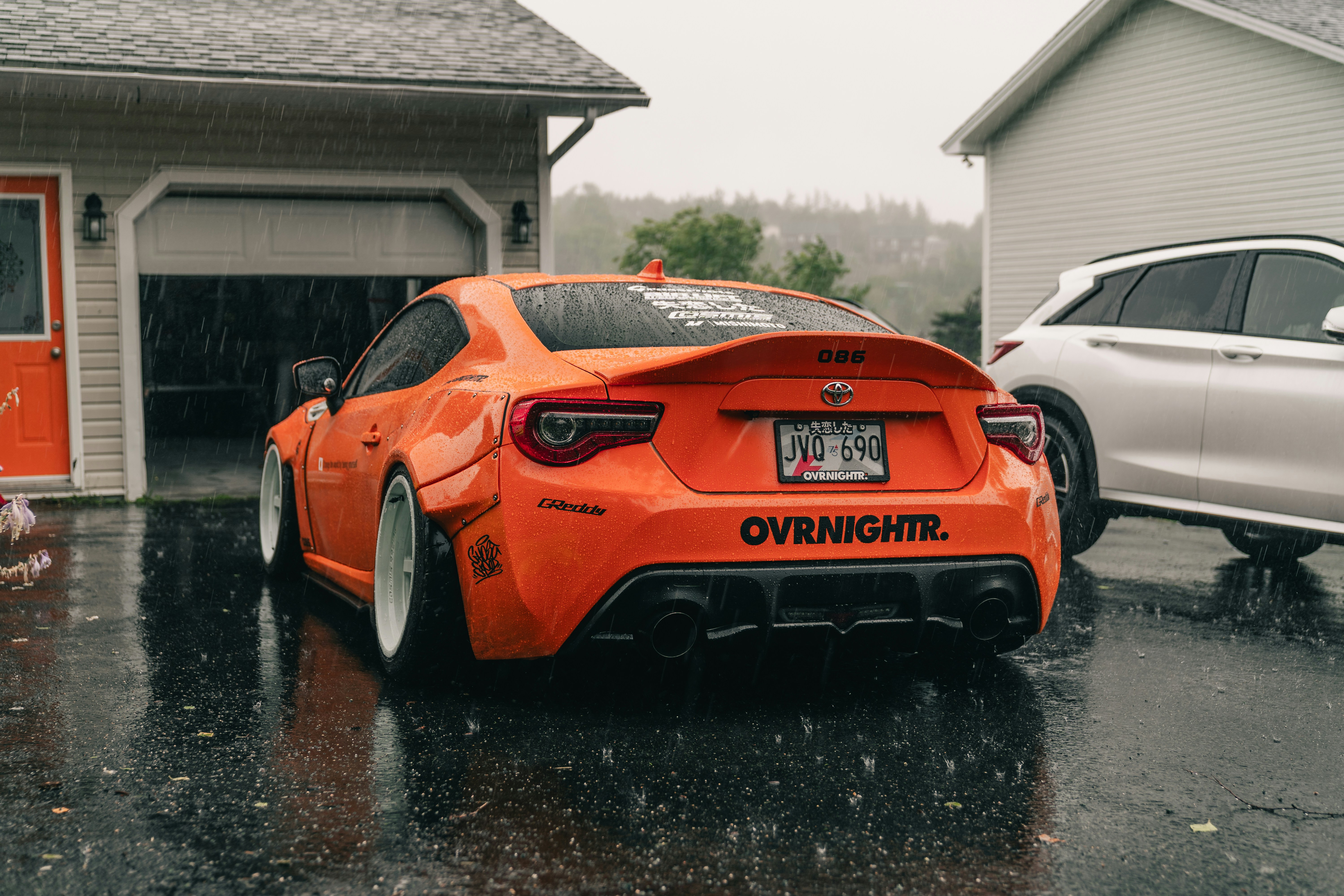 Orange Chevy on a Rainy Runway: Night Rider in the Driveway