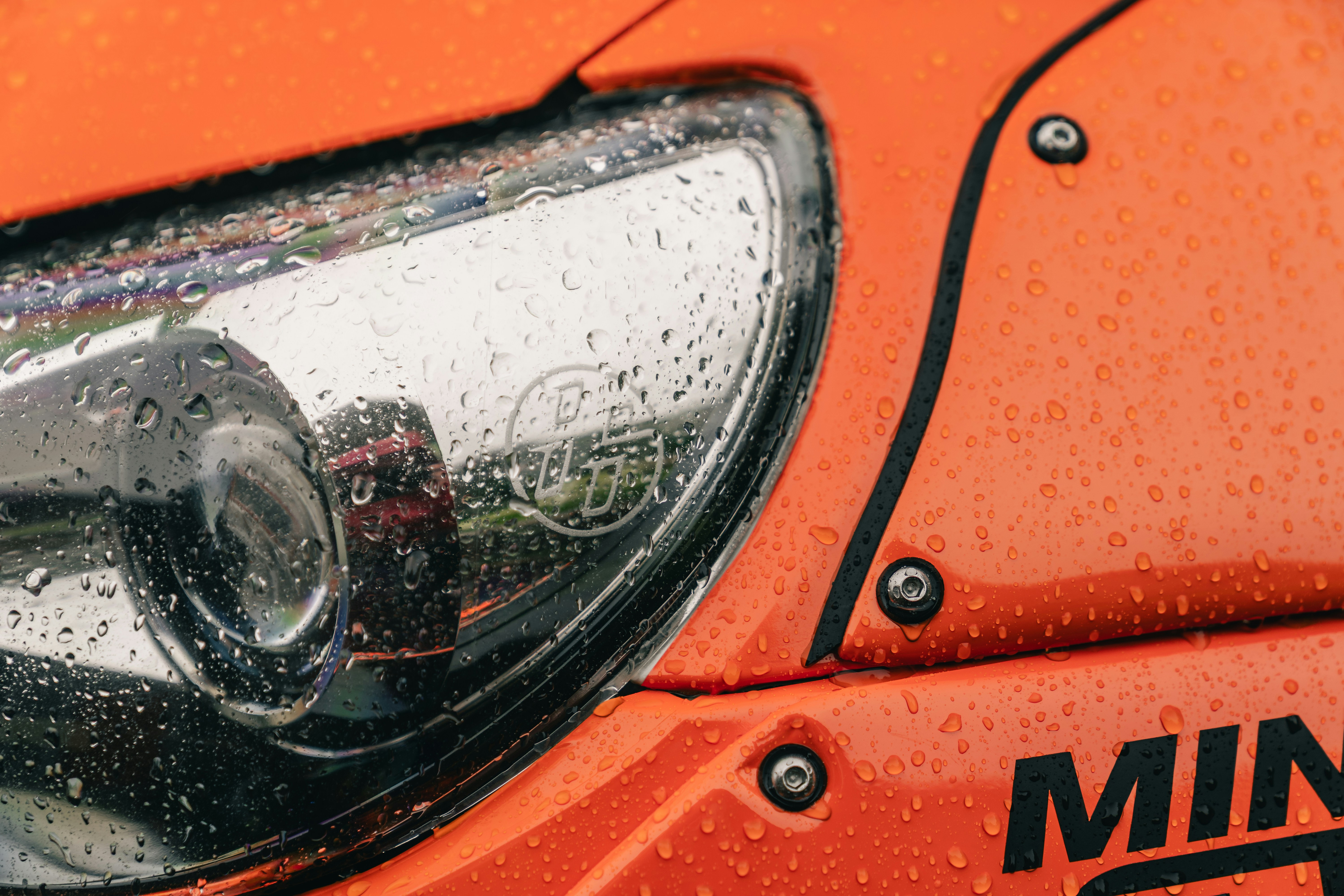 Orange Curves and Wet Glass: A Close-Quarters Car Headlight Detail