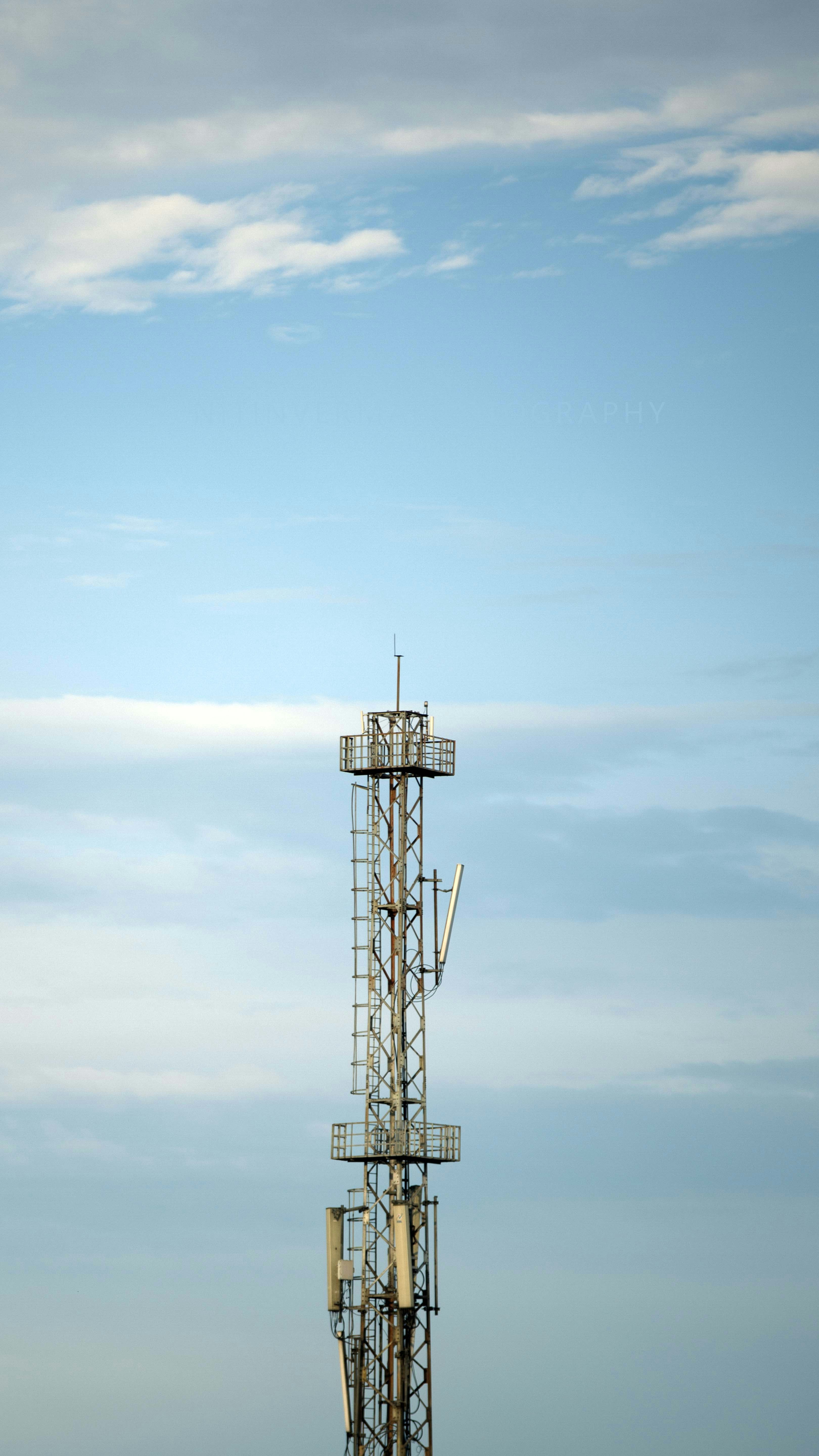 Skyward Signal: A lone broadcast mast Pierces the Calm