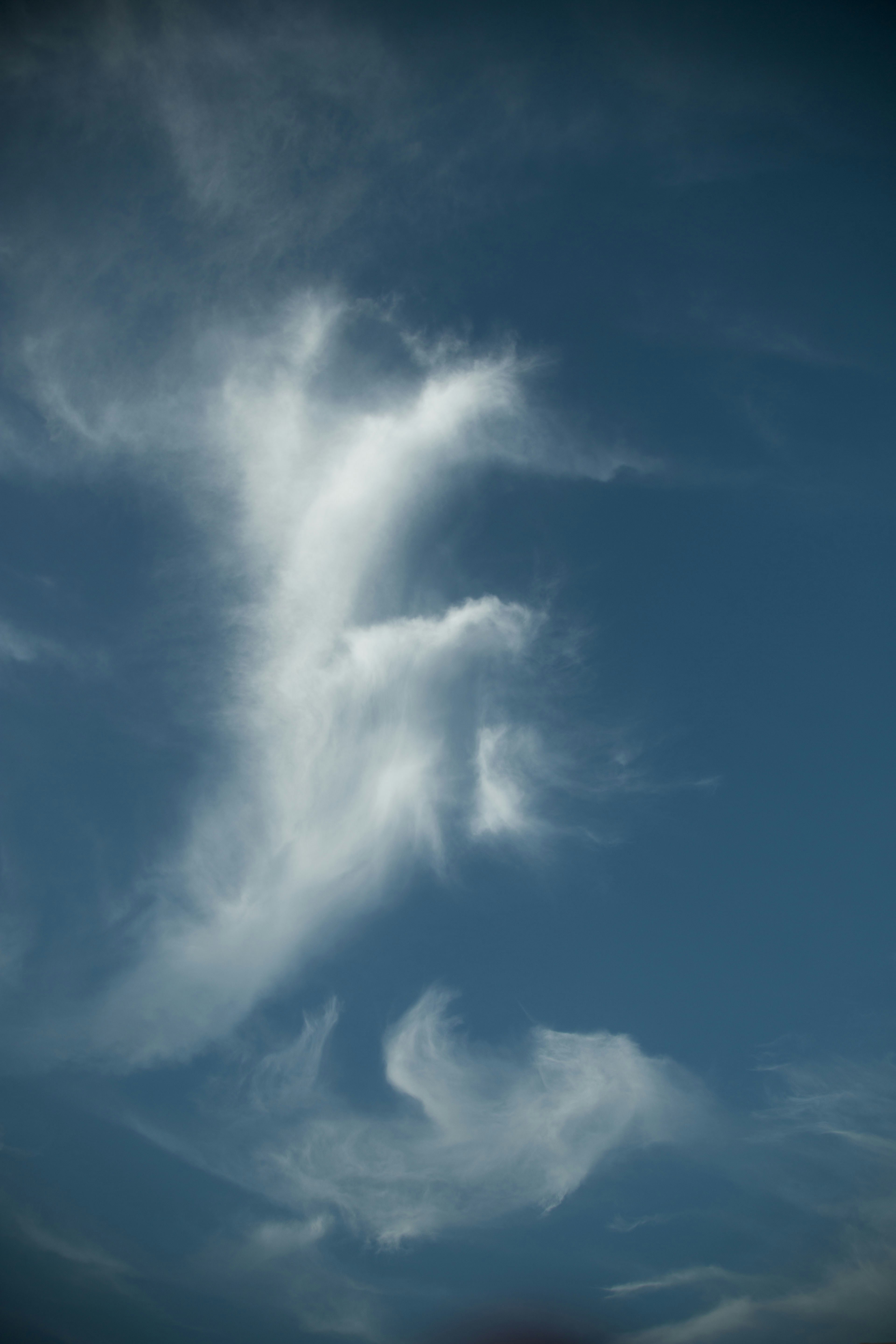 Tapering Cloud Whispers in a Cerulean Sky