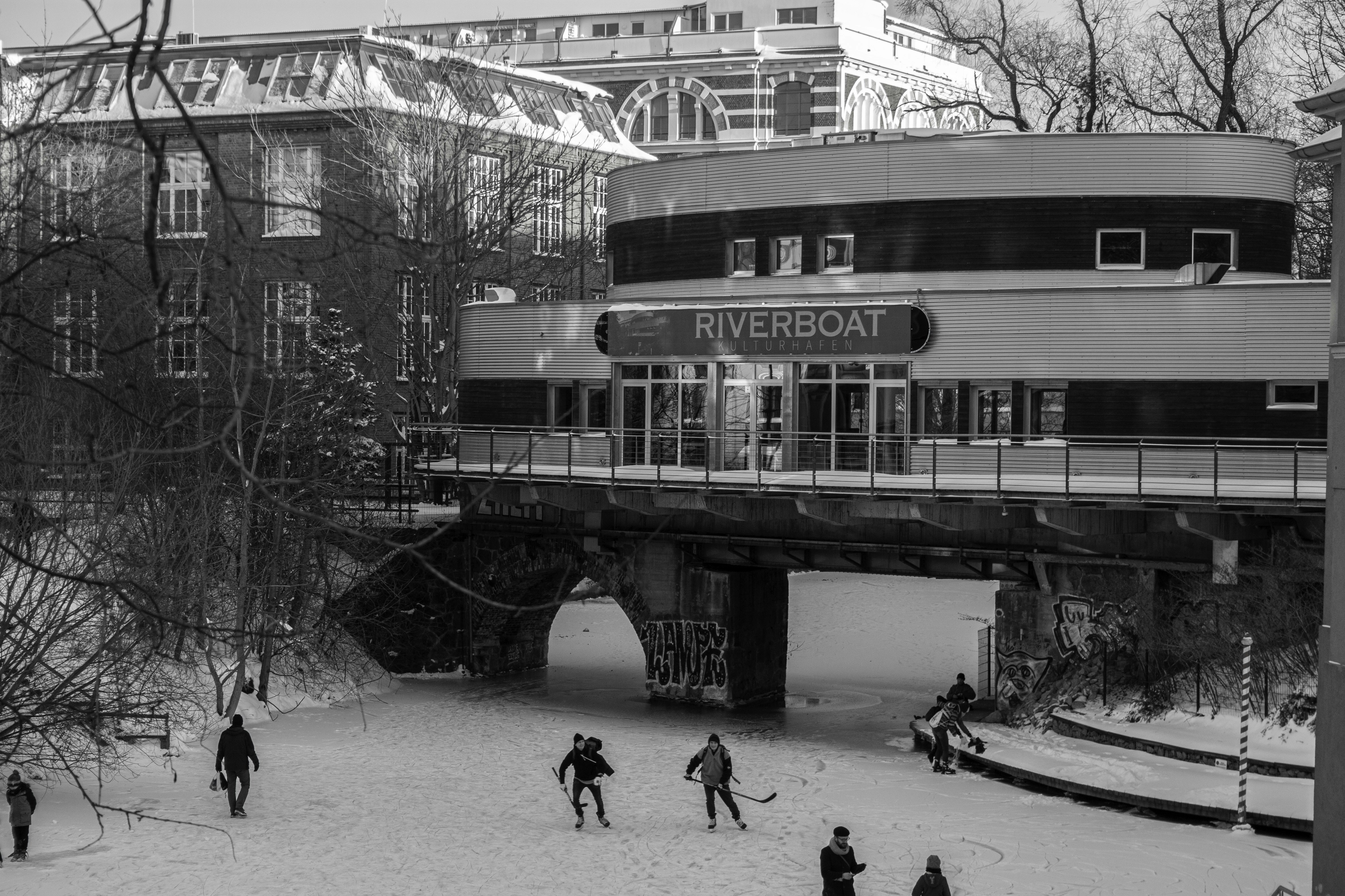 Riverboat on a Seasoned Canal: Winter Scene Under the Bridge