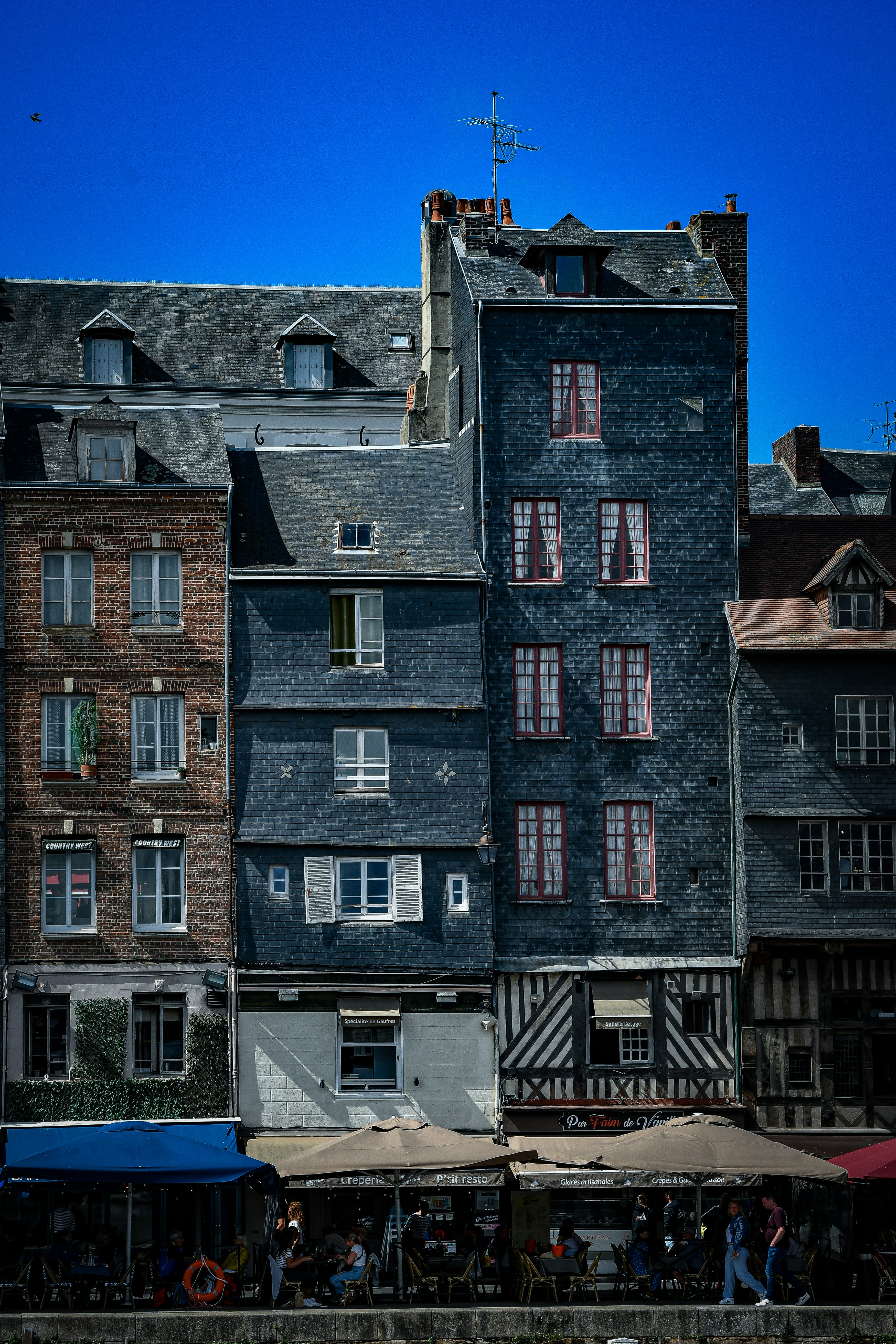 Colorful Facades and Café Columns in a Historic Street Scene