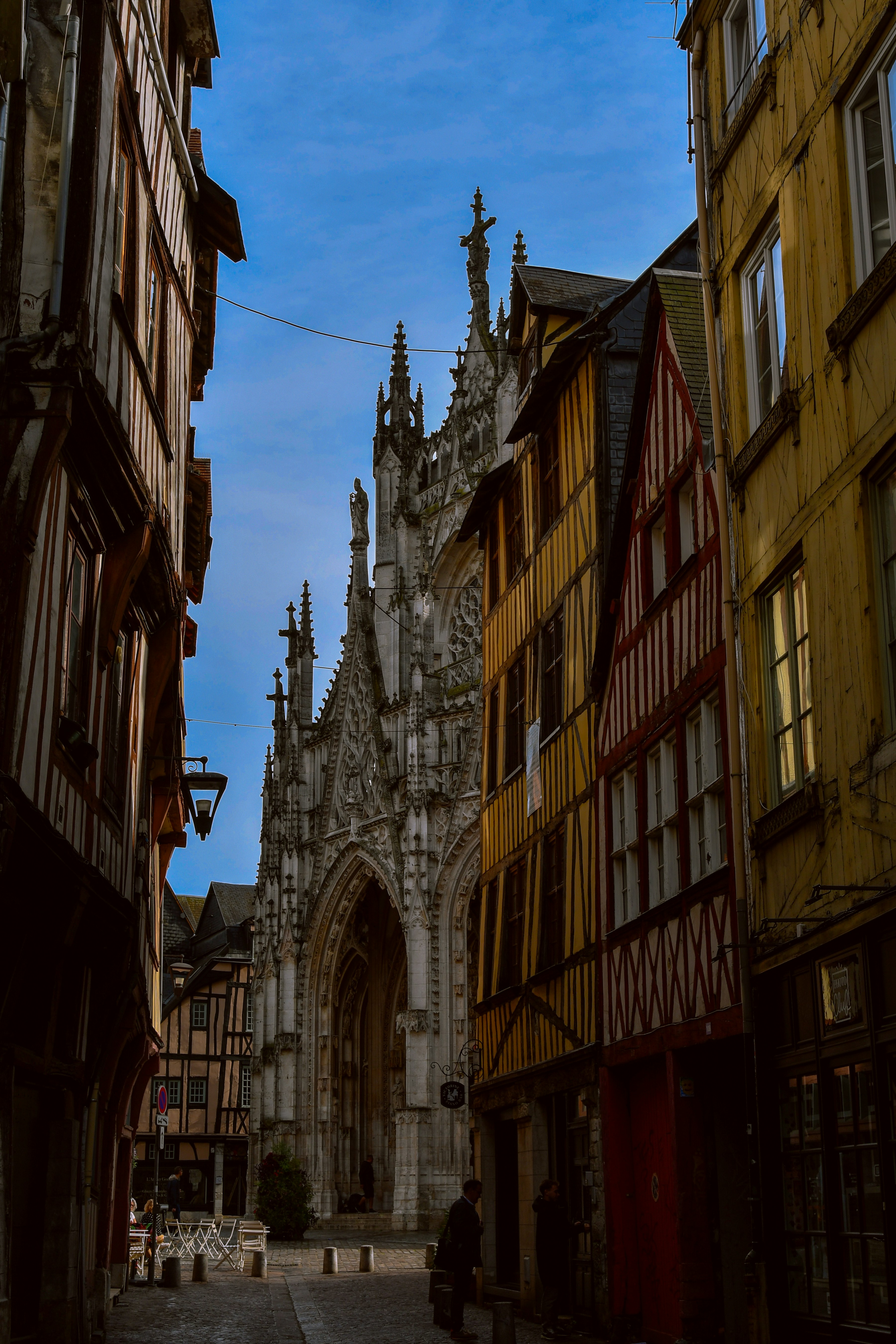 Gothic Cathedral Framed by Colorful Timbers on a Narrow Street