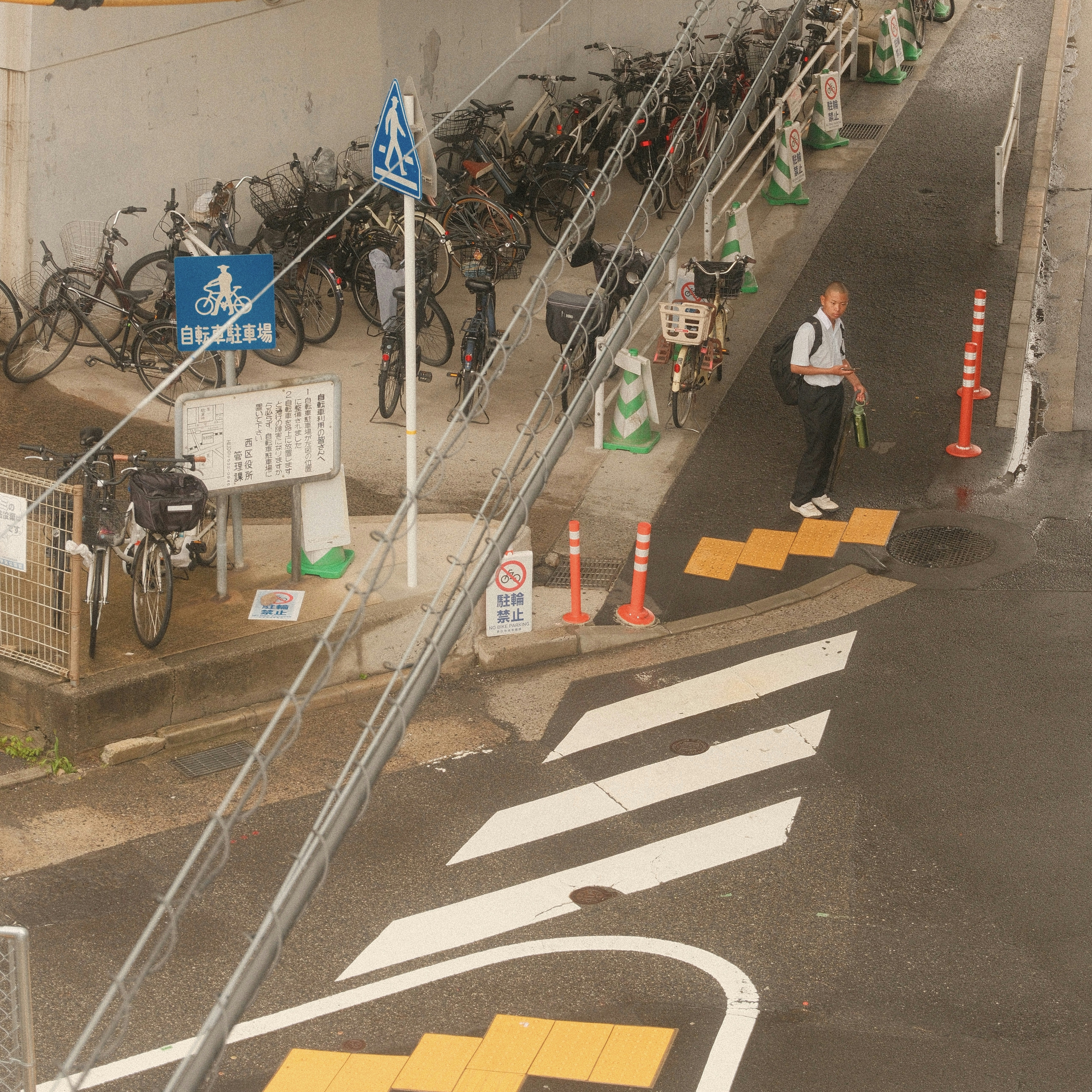 Crosswalk Corner: A Quiet Moment Amid Bicycle Stacks