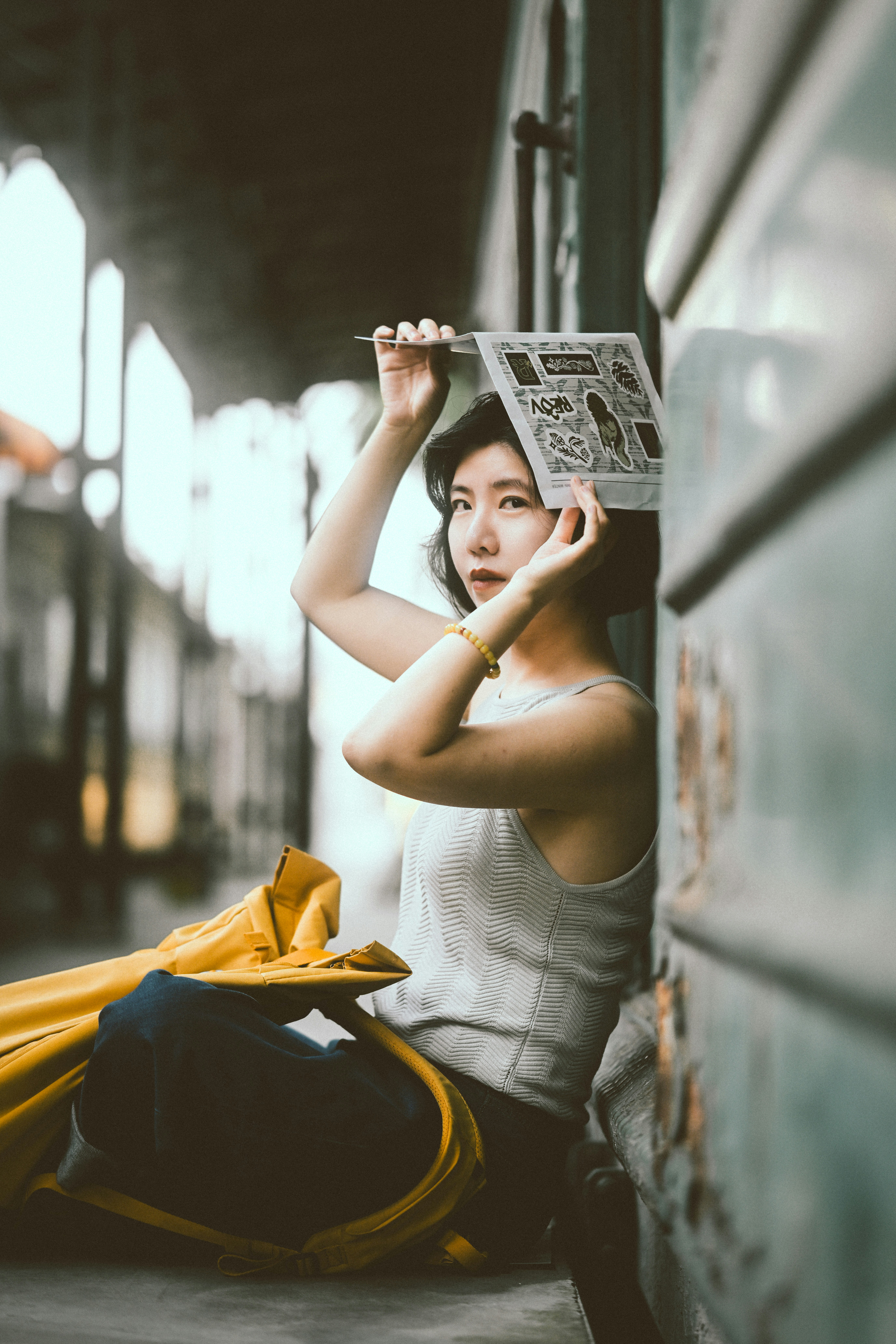 Holding a Quiet Moment: A Woman with a Newspaper at the Edge of a Platform