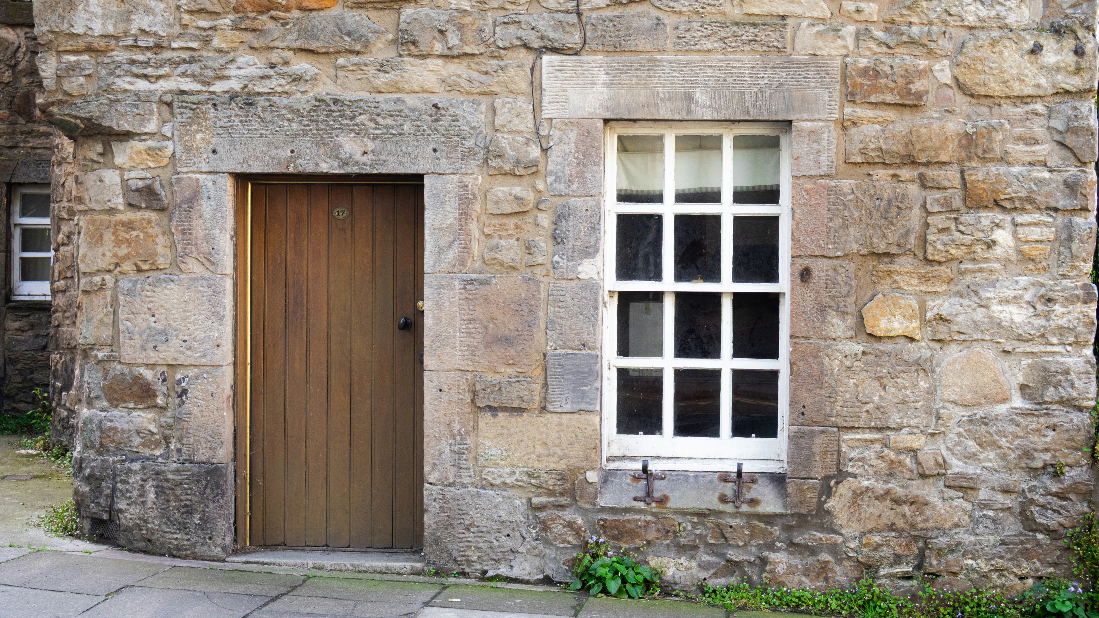 Stone Cottage Doorway Framed by Window and Ivy