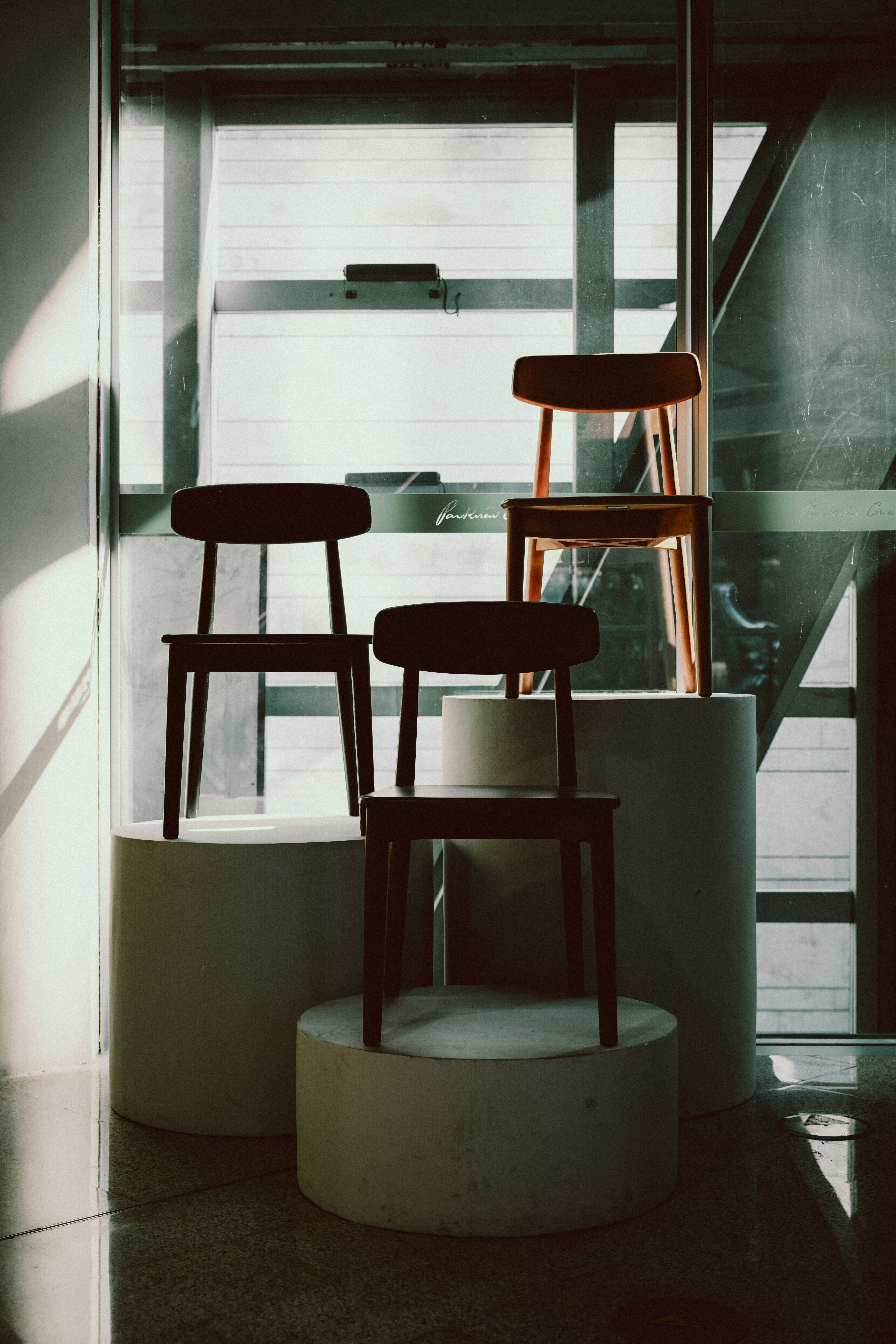 Stacked Chairs in Sunlit Gallery: Silent Geometry