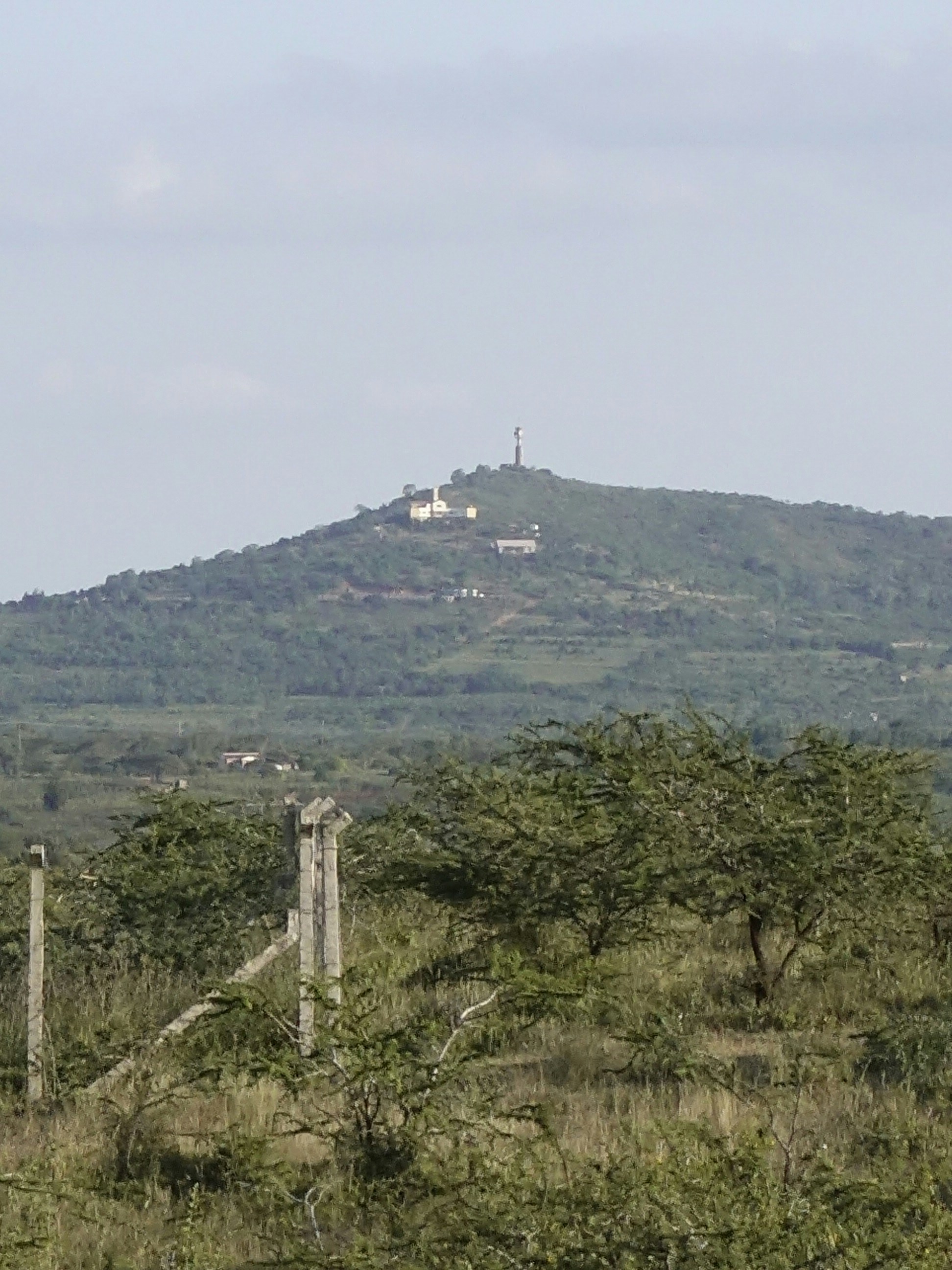 Hilltop beacon: a quiet ascent to the distant lighthouse